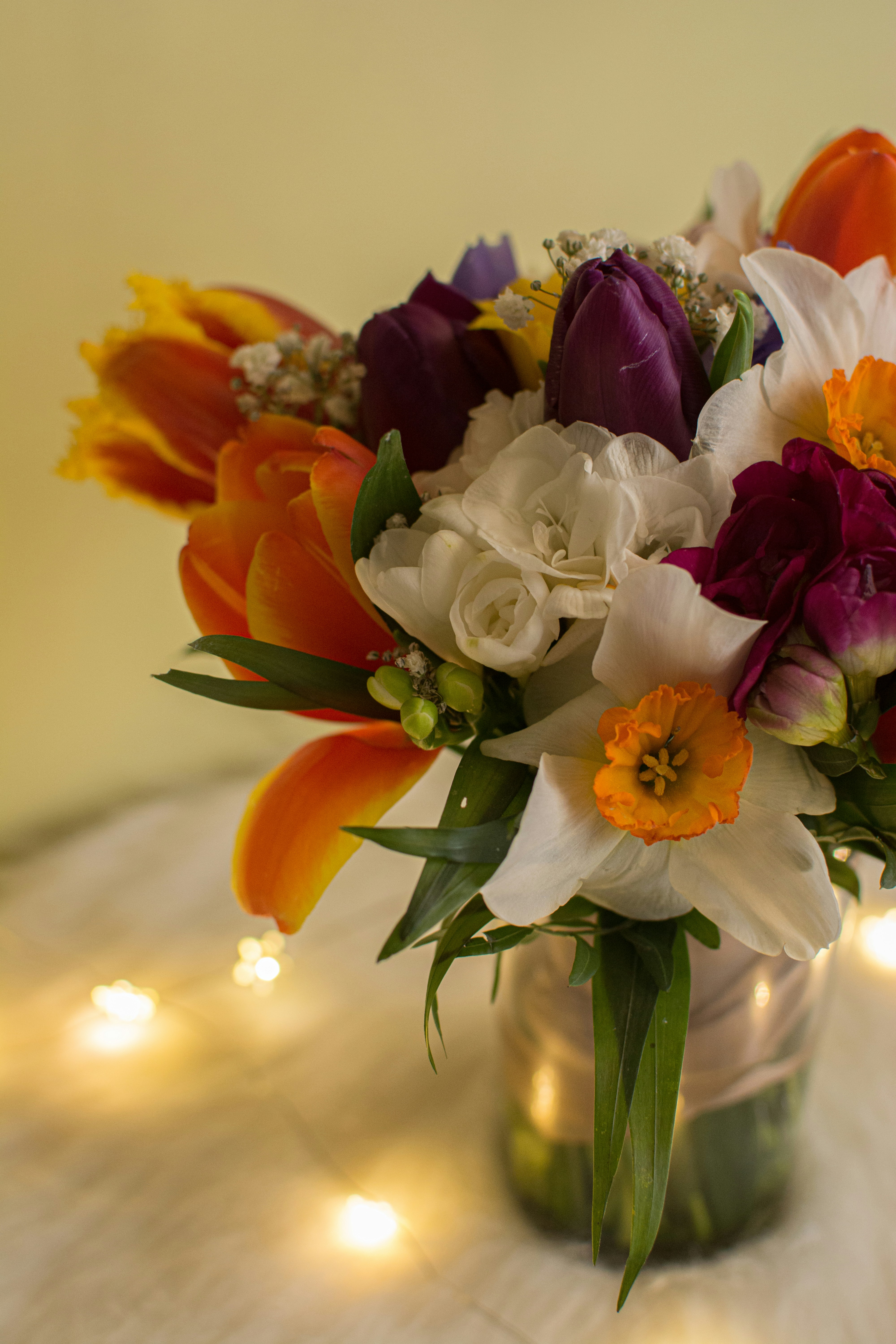 Candlelit Cascade: Tulips and White Roses in a Glass Vase