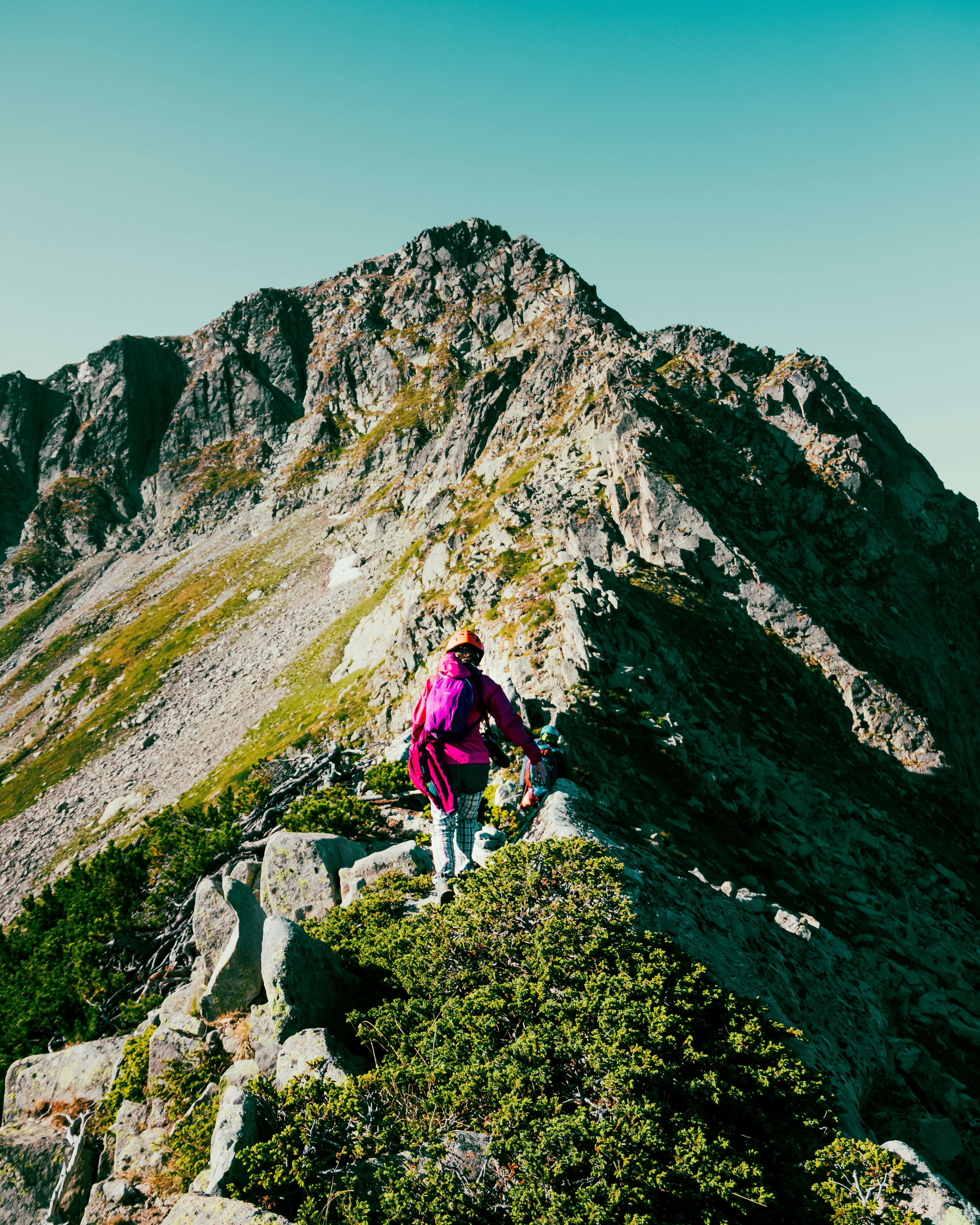 A person climbing up a mountain with a backpack photo – Free Pirin ...