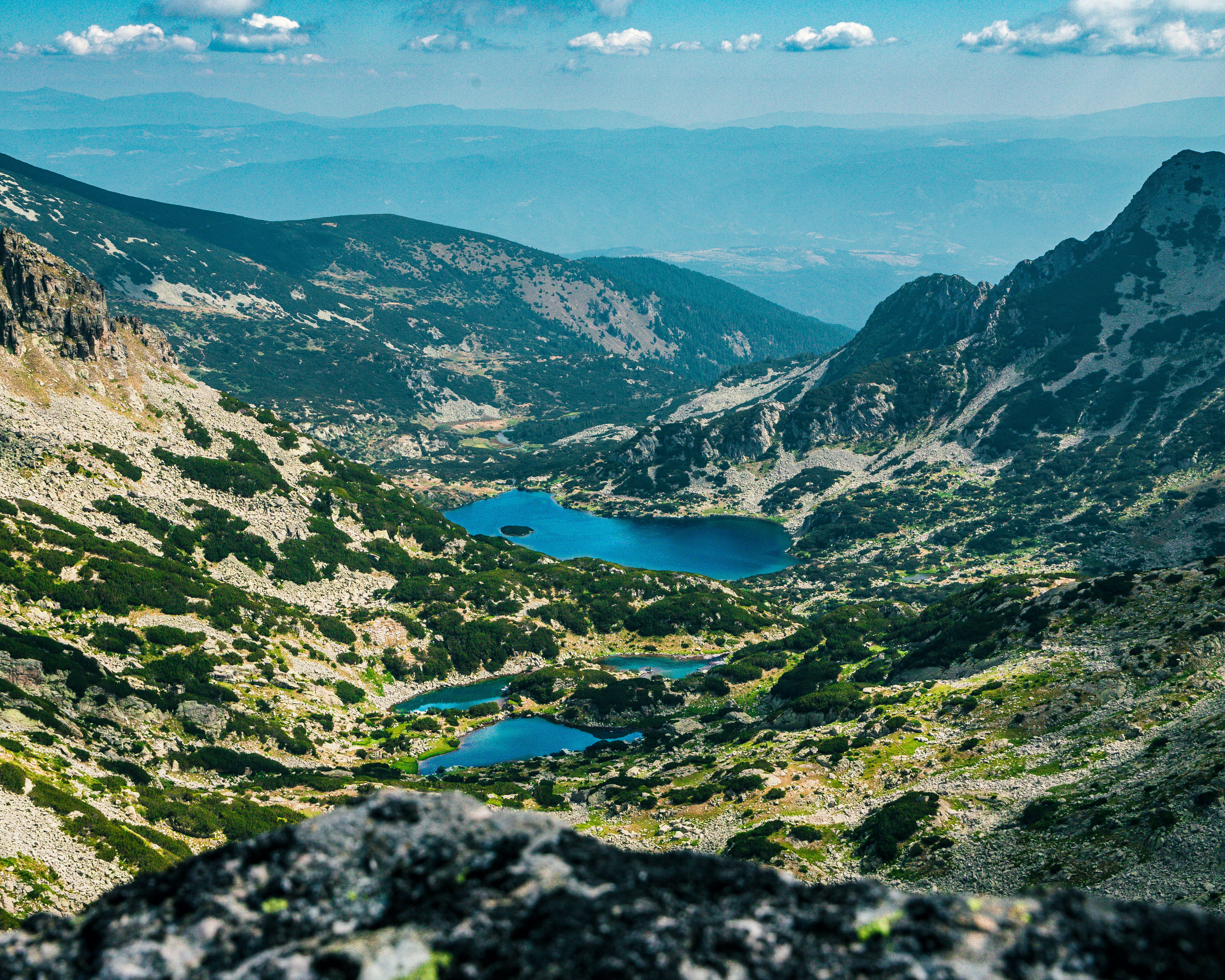 a view of a mountain range with a lake in the middle