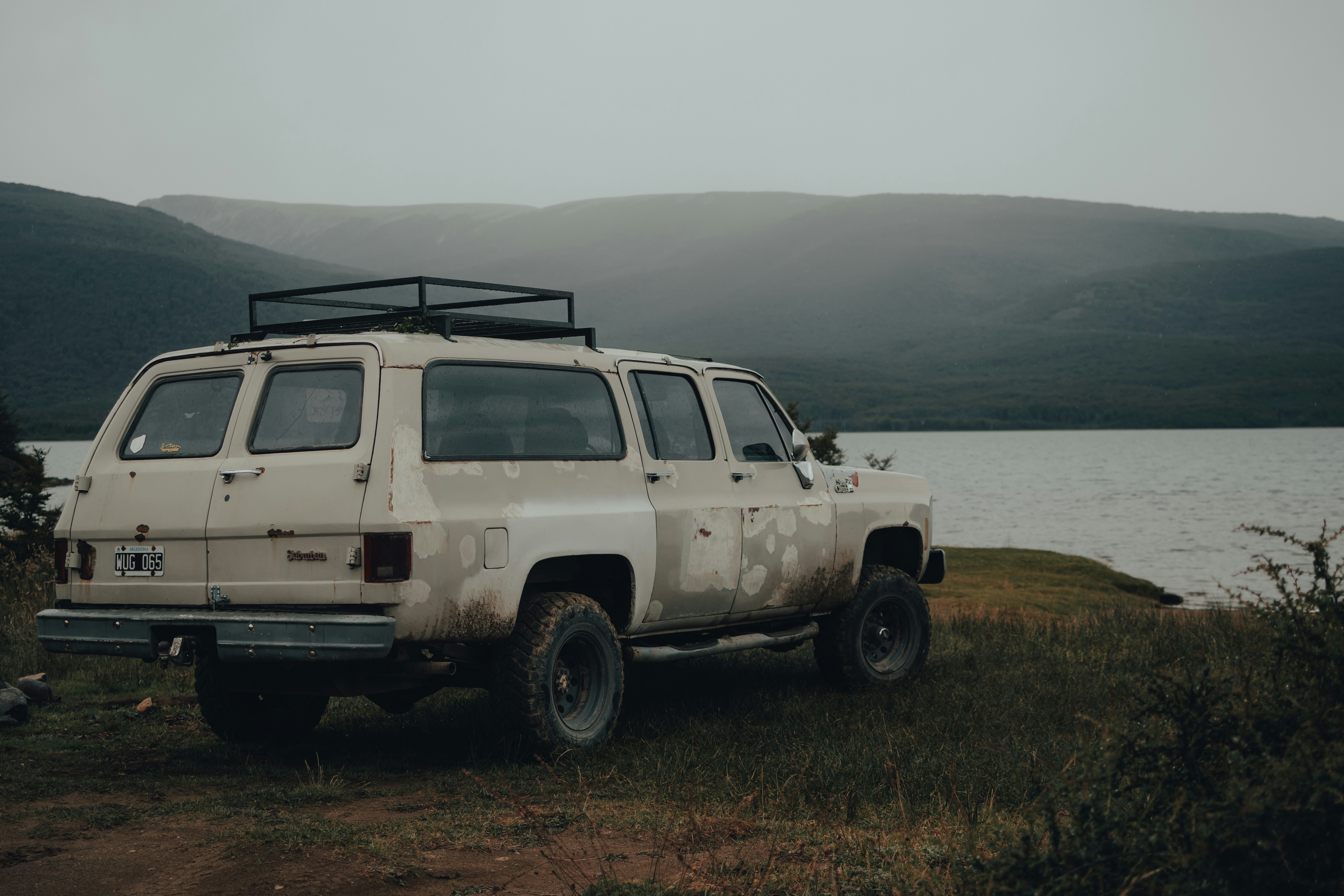 Weathered Explorer by a Misty Highland Lake