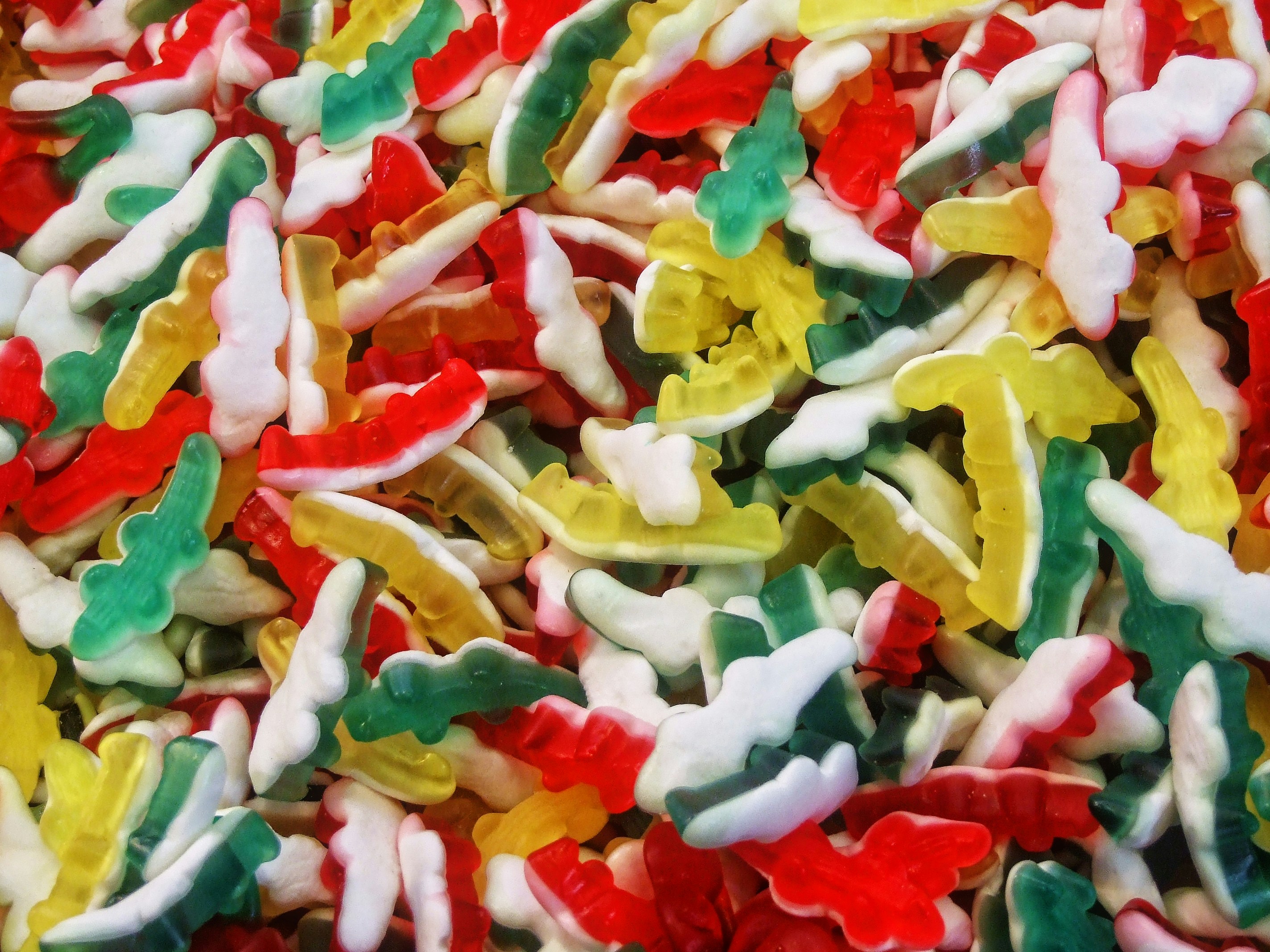 Vibrant assortment of gummy candies in various colors and shapes, creating a playful and inviting scene.