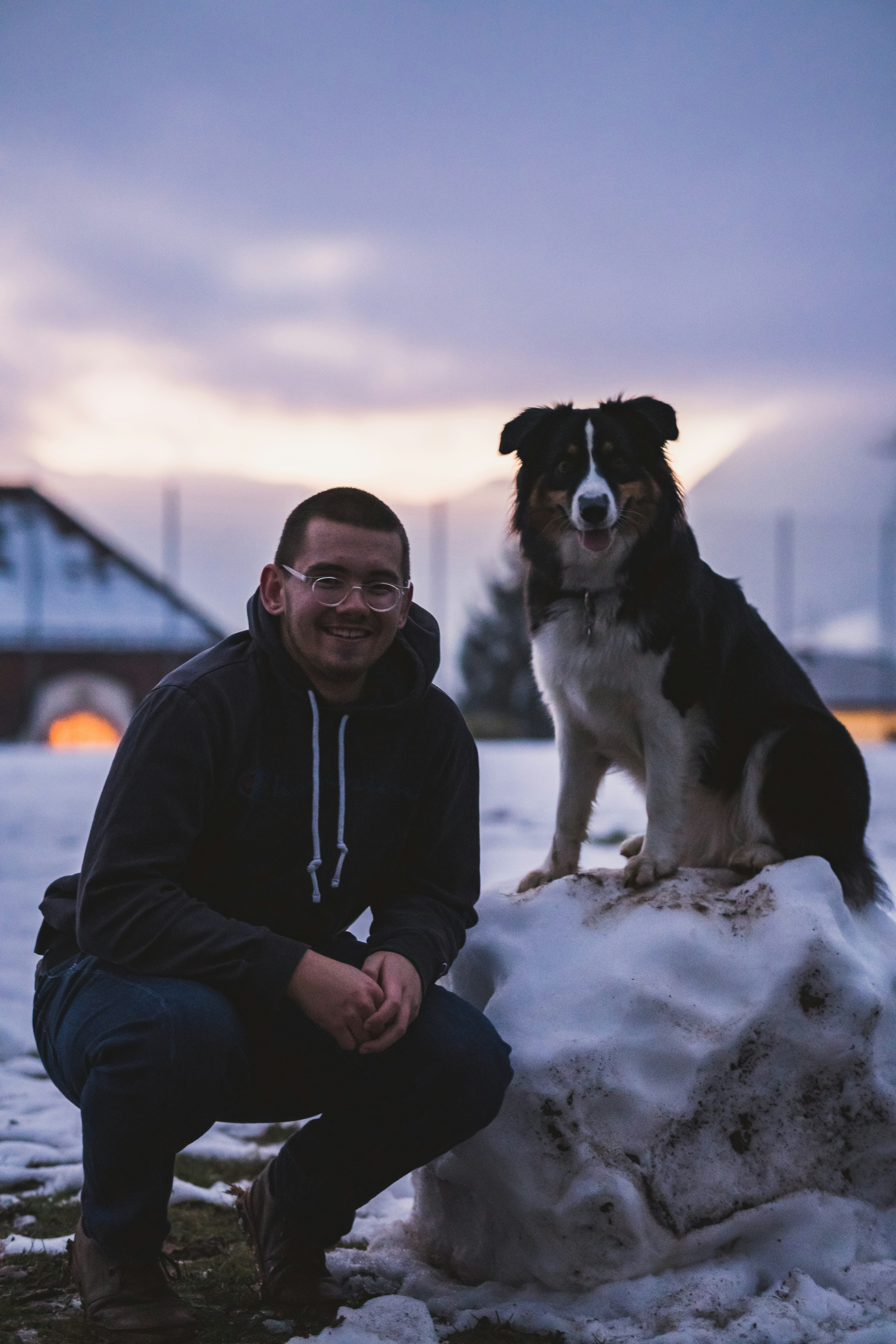 Snowbound Moment: A Man and His Border Collie at Dusk