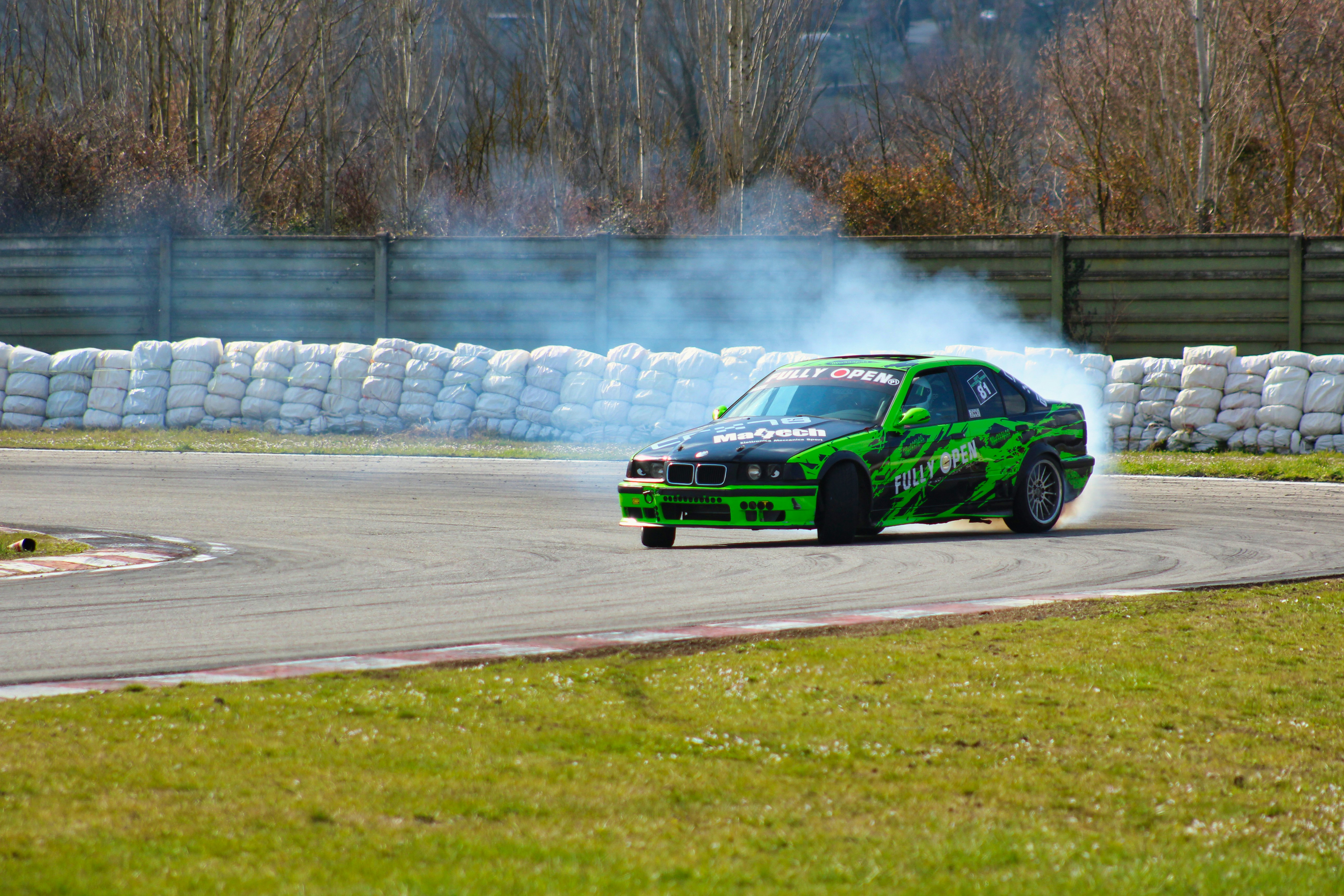 a green car driving on a race track