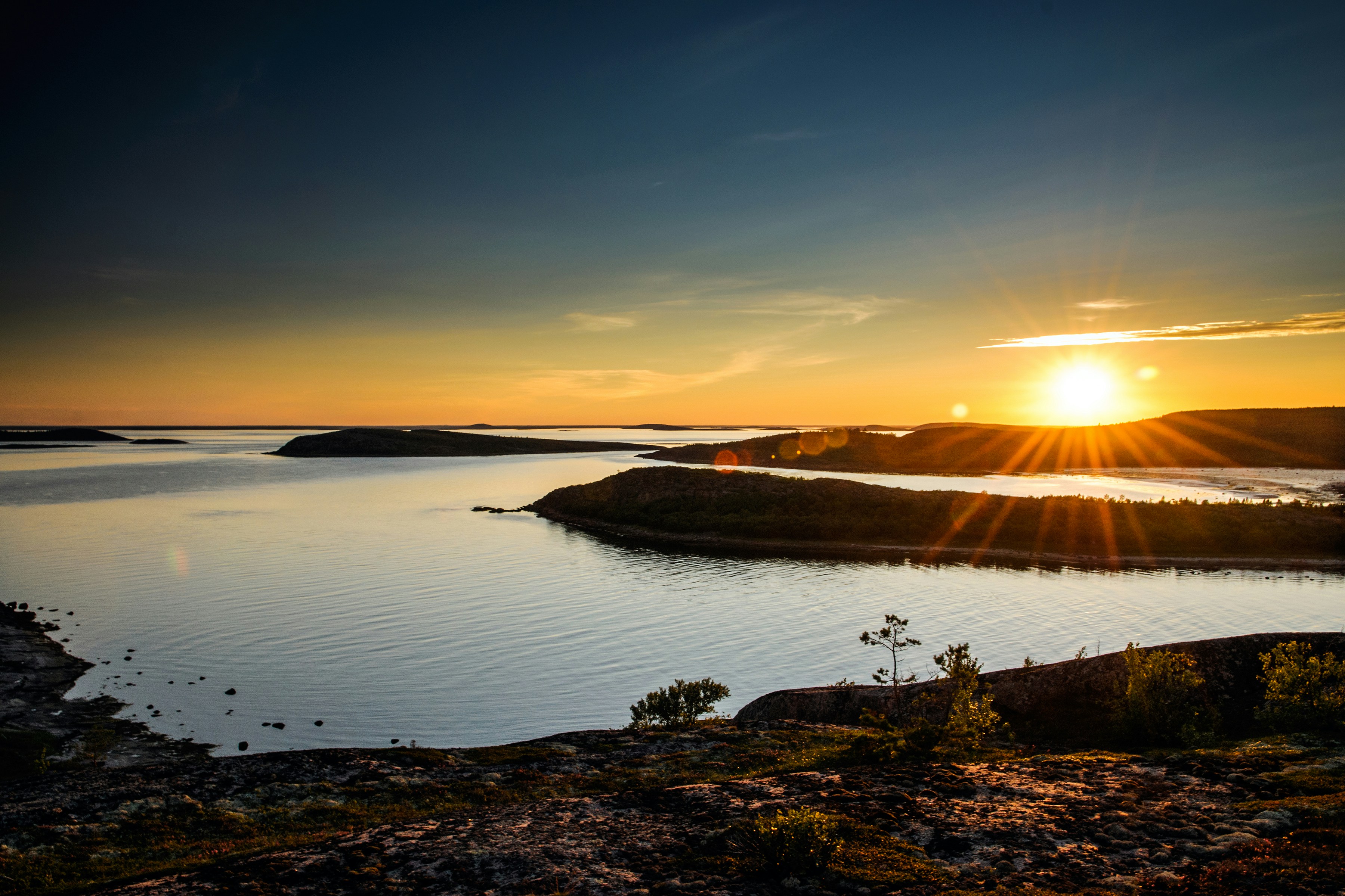 The sun is setting over a body of water photo – Free Nature Image on ...