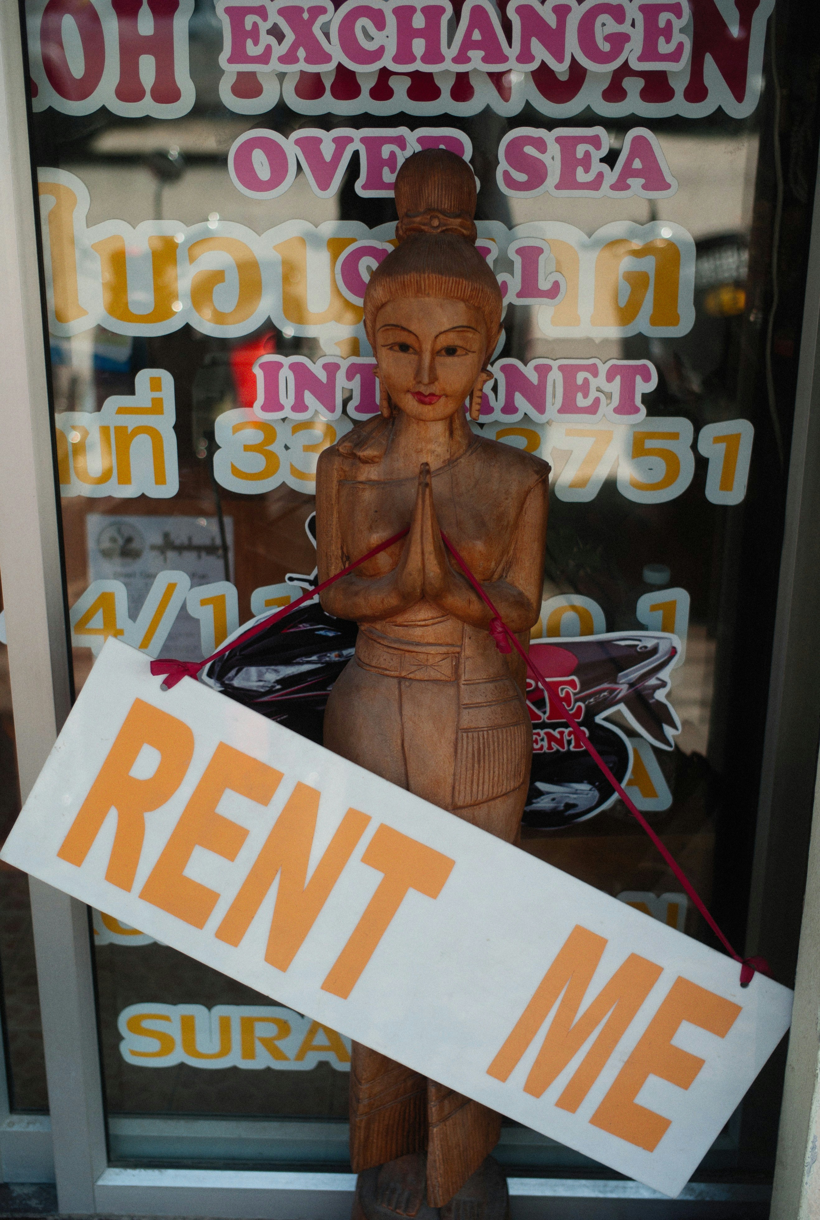 A statue of a woman holding a rent me sign photo – Free Advertisement ...