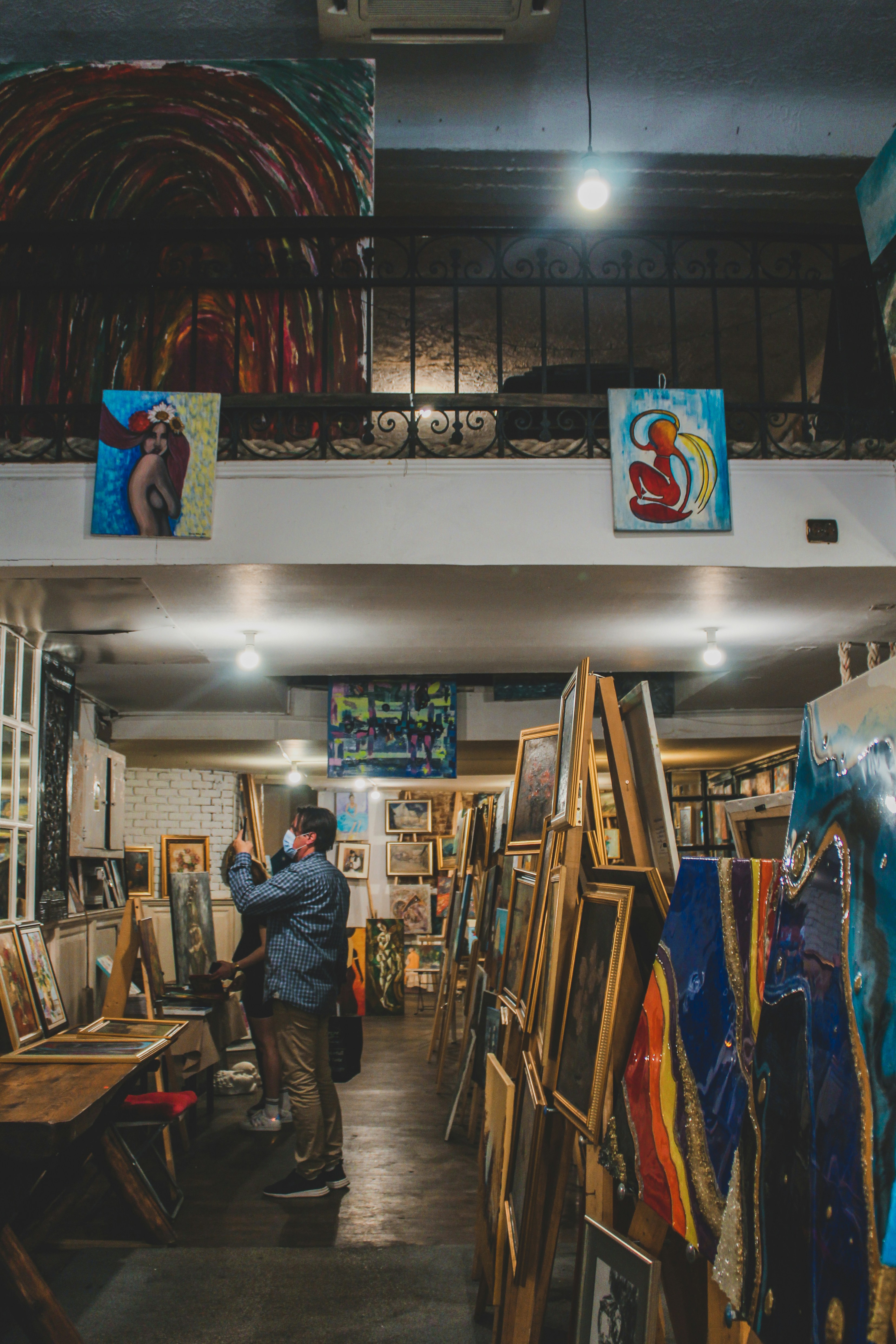 Artist at Work in a Gallery-Lilled Studio Corridor