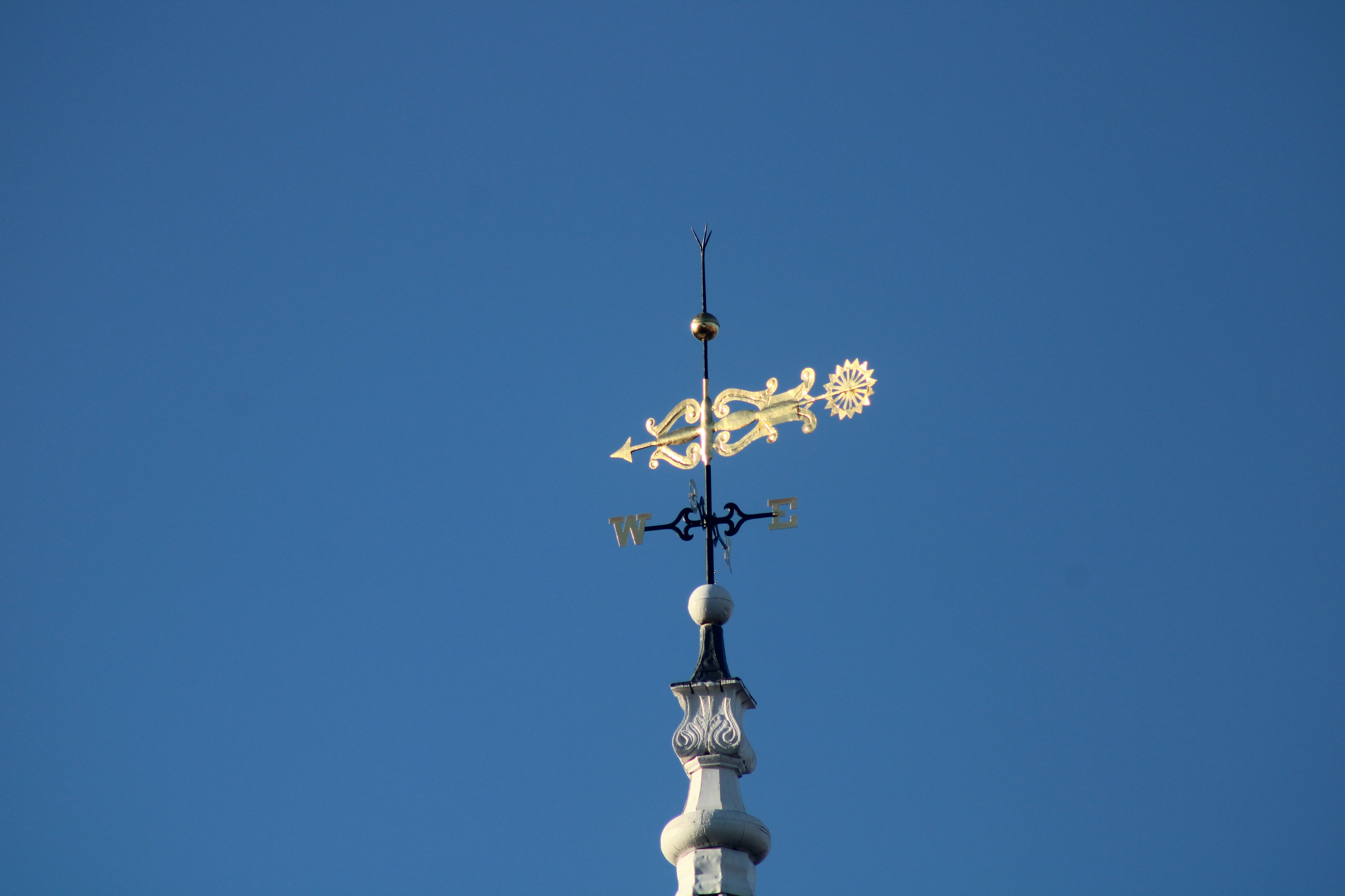 A weather vane on top of a building photo – Free Weather vane Image on ...