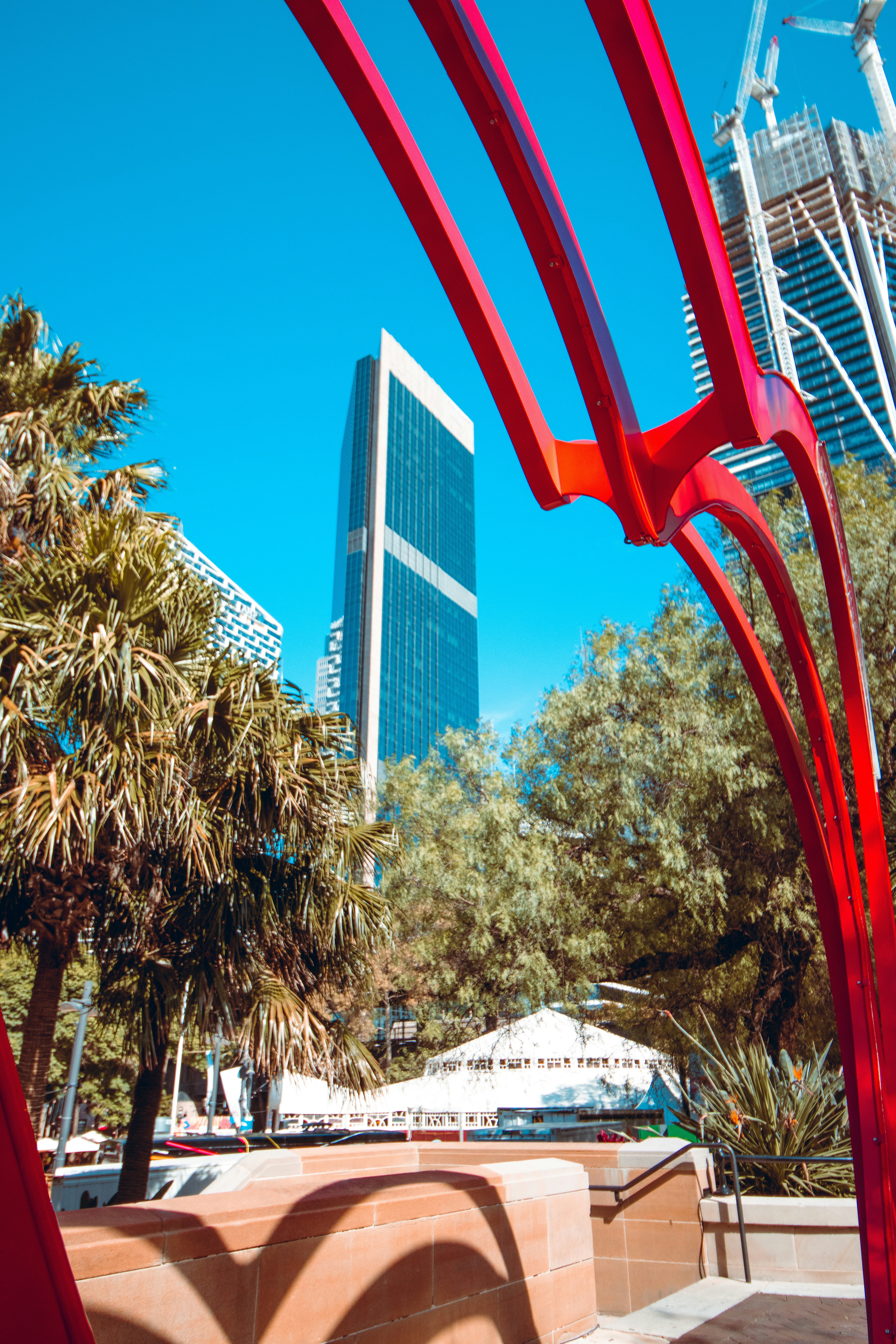 A red sculpture in front of a tall building photo – Free City Image on ...