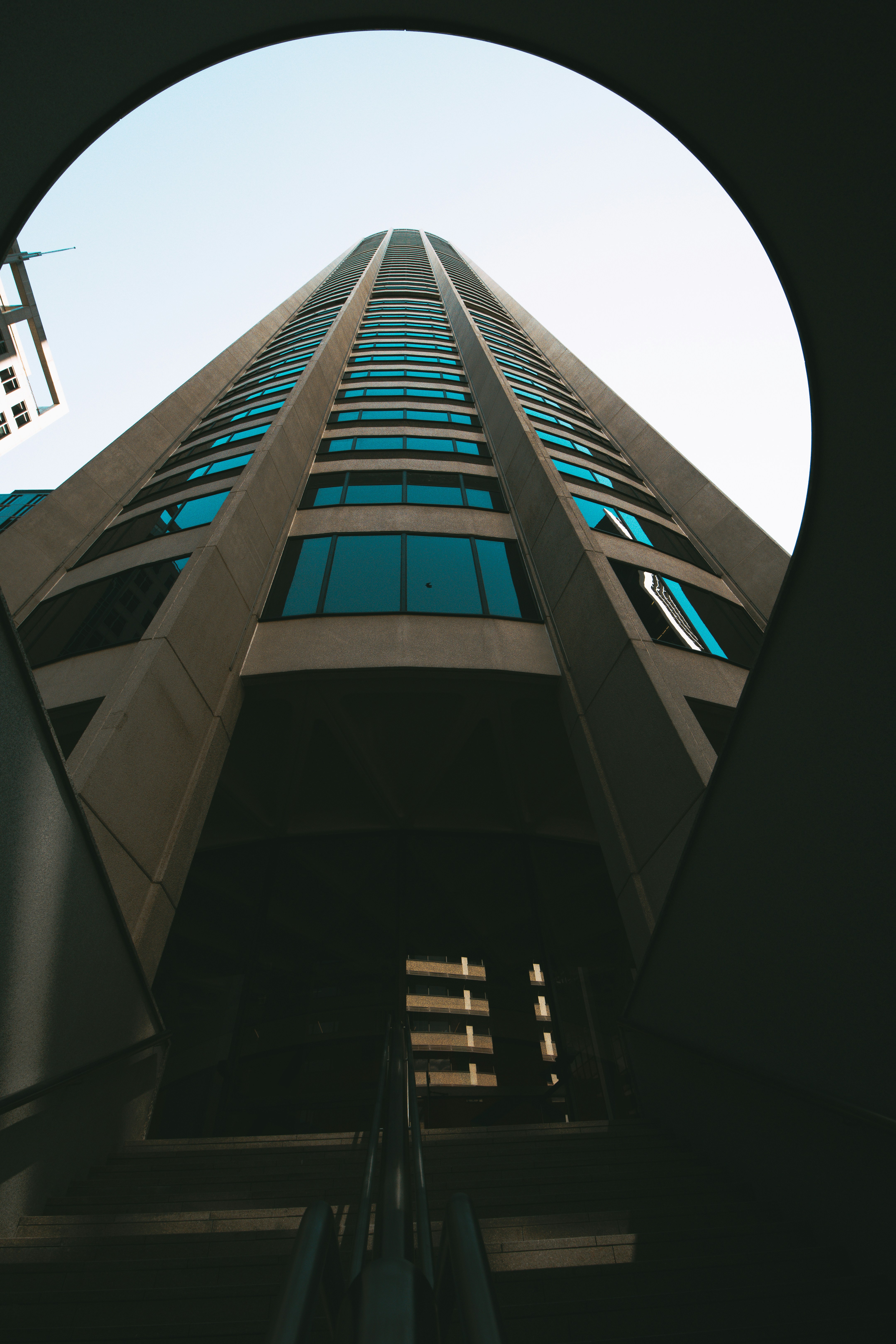 Looking up at a tall building through a circular window photo – Free ...