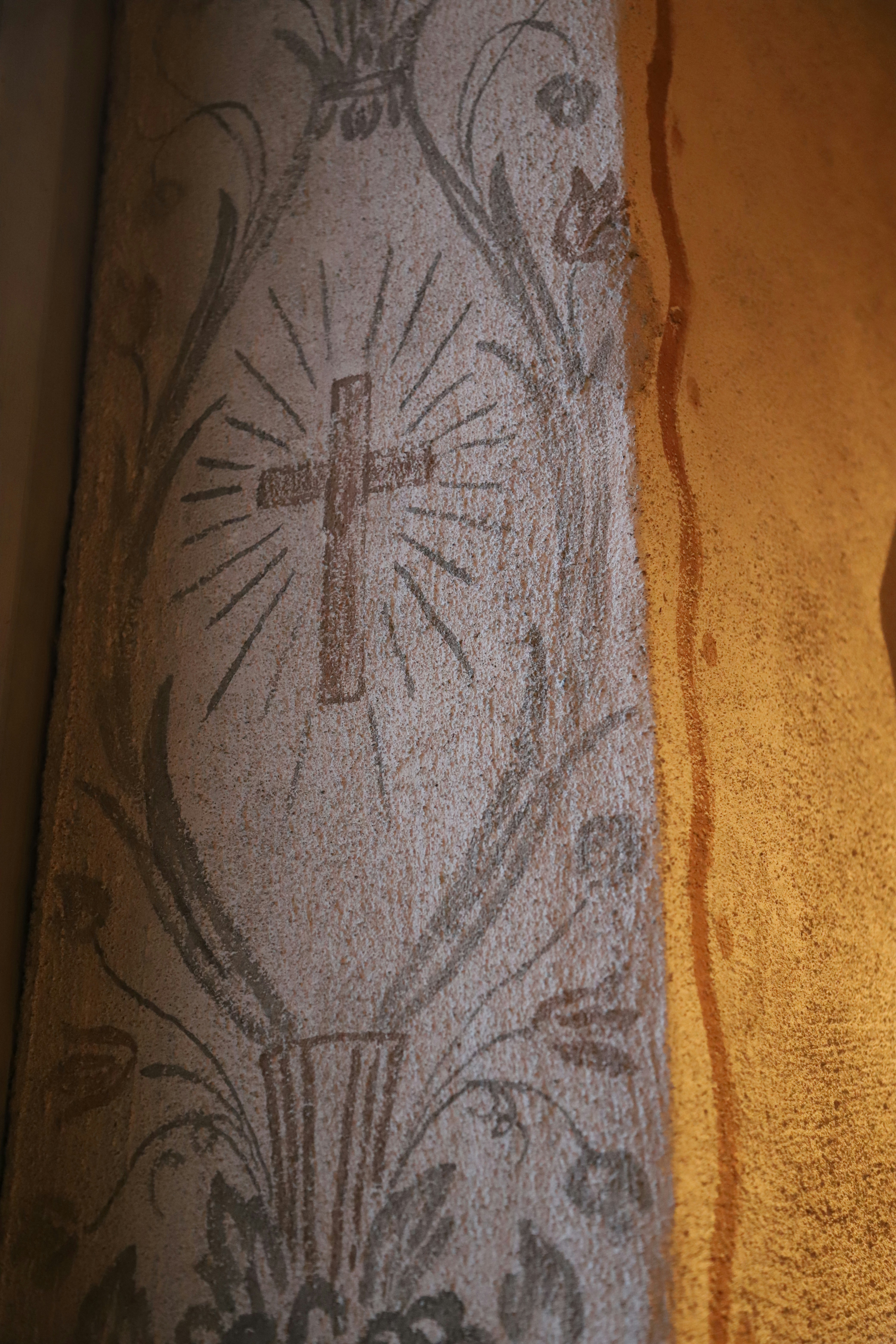Sunlit Cross: A Stone Bas-Relief in an Ornate Niche