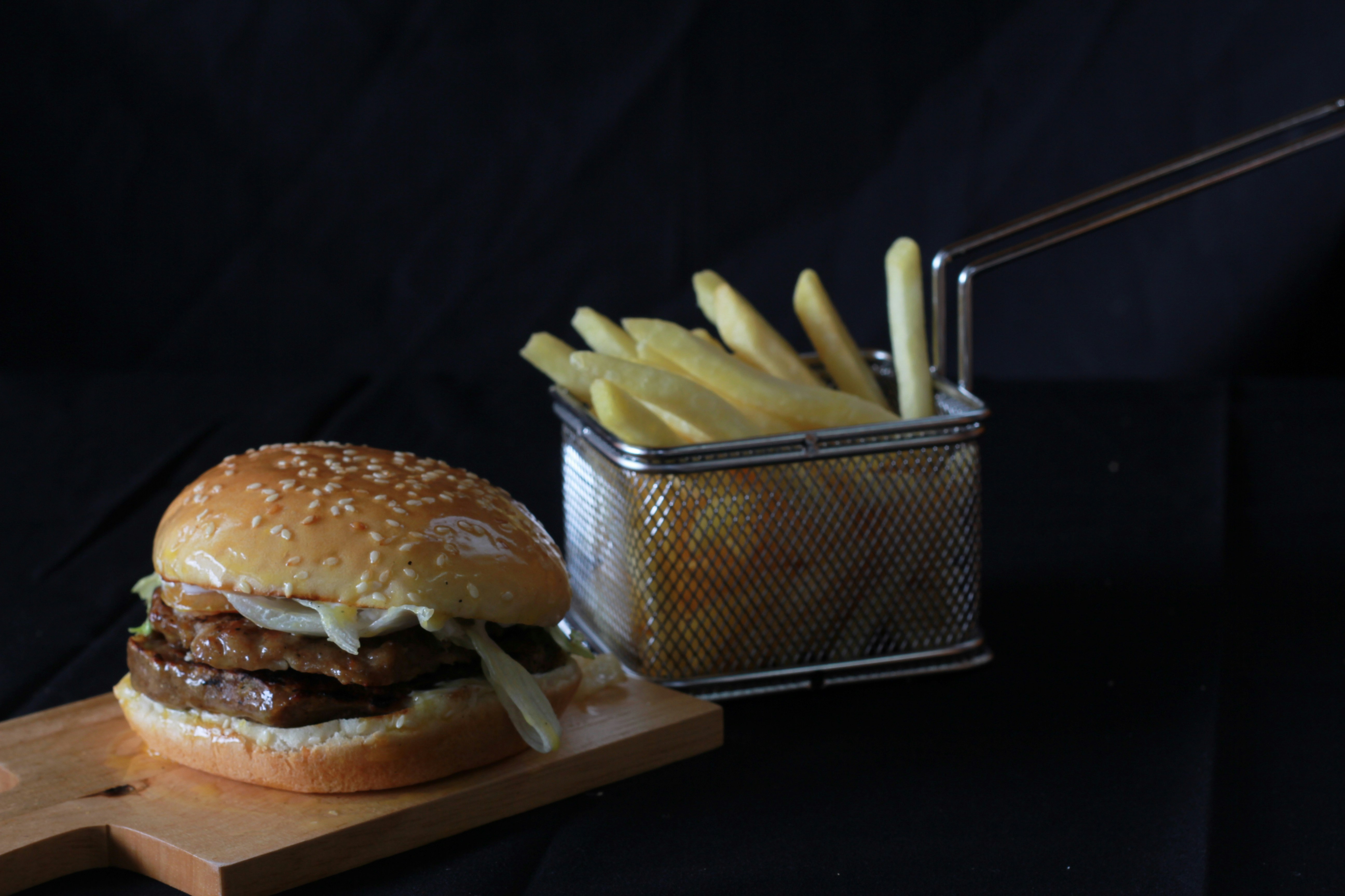 Midnight Crunch: Burger on Wood and Fries in Studio Noir