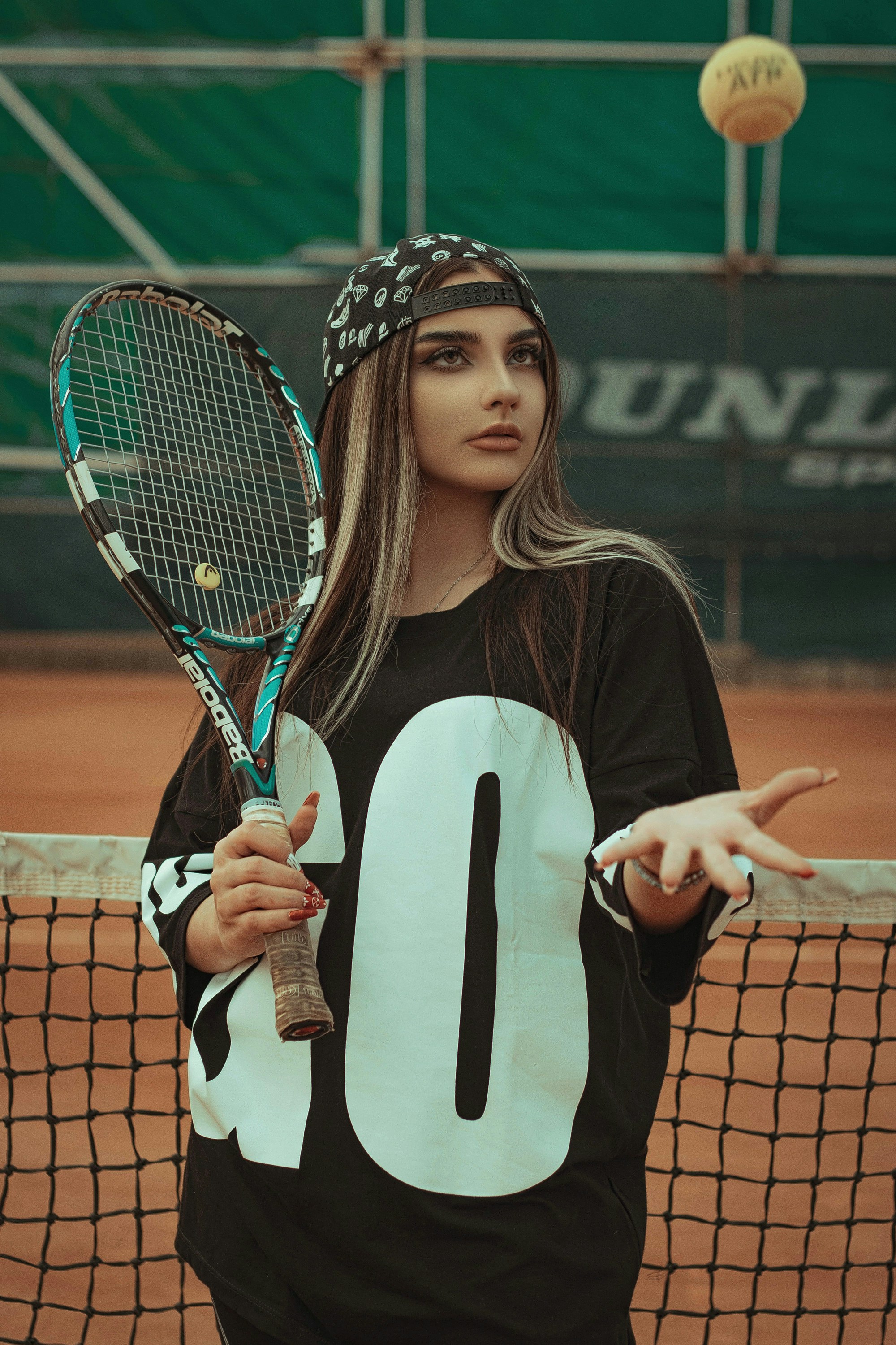 A woman holding a tennis racquet on top of a tennis court photo – Free ...