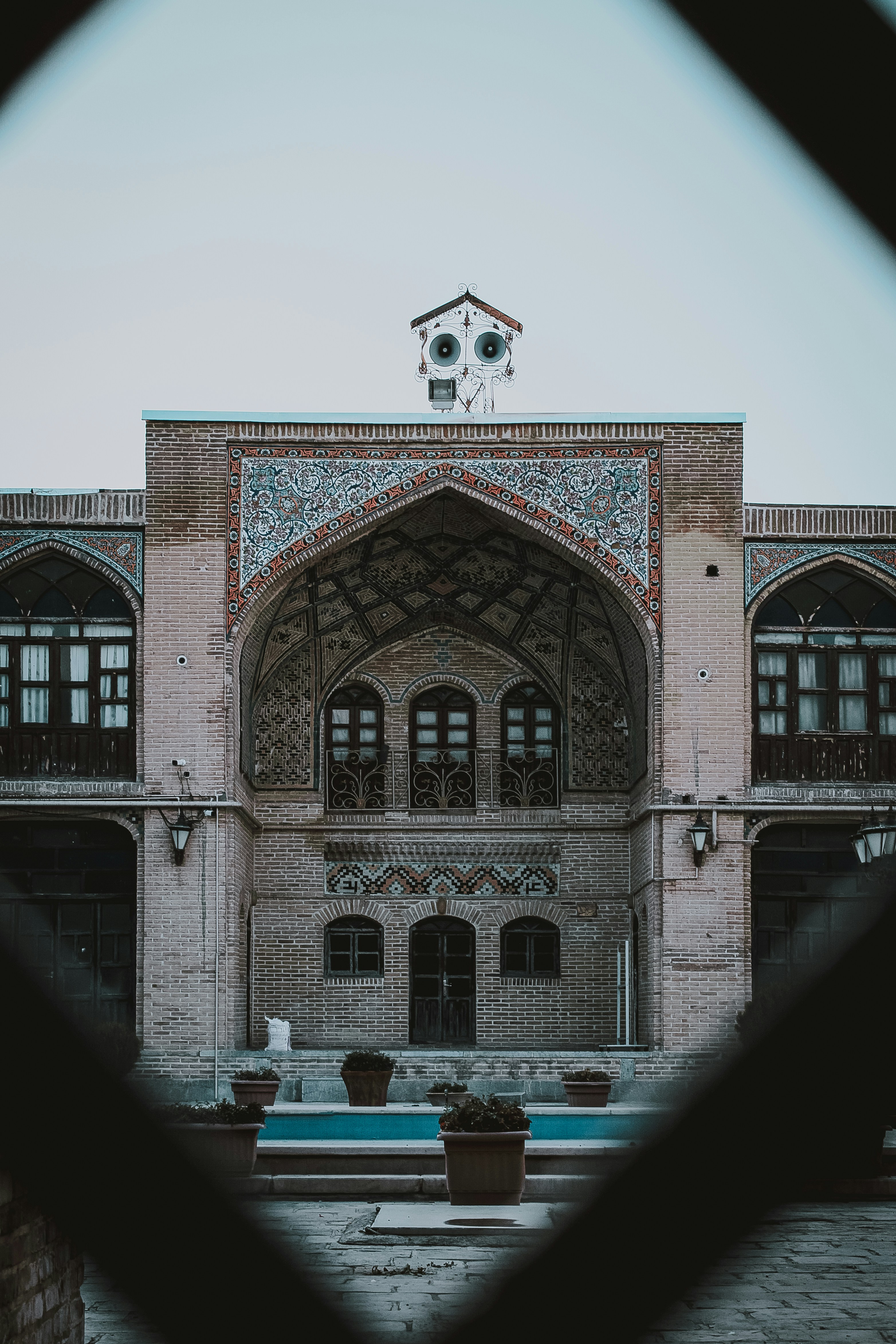 Brick-Arch Portal: Mosaic Tilework Framed by a Circular View