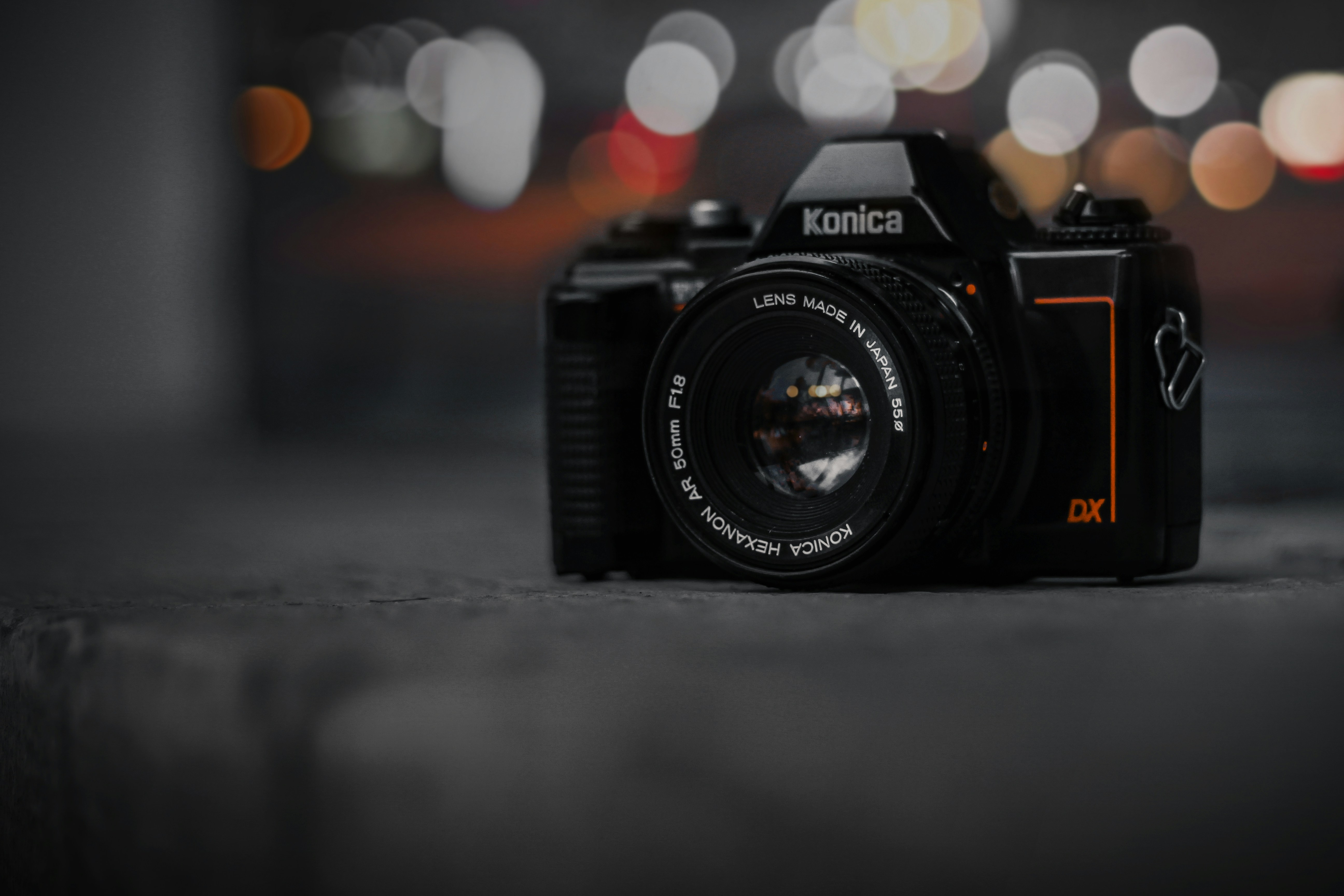Midnight Focus: A Konica SLR rests under city glow