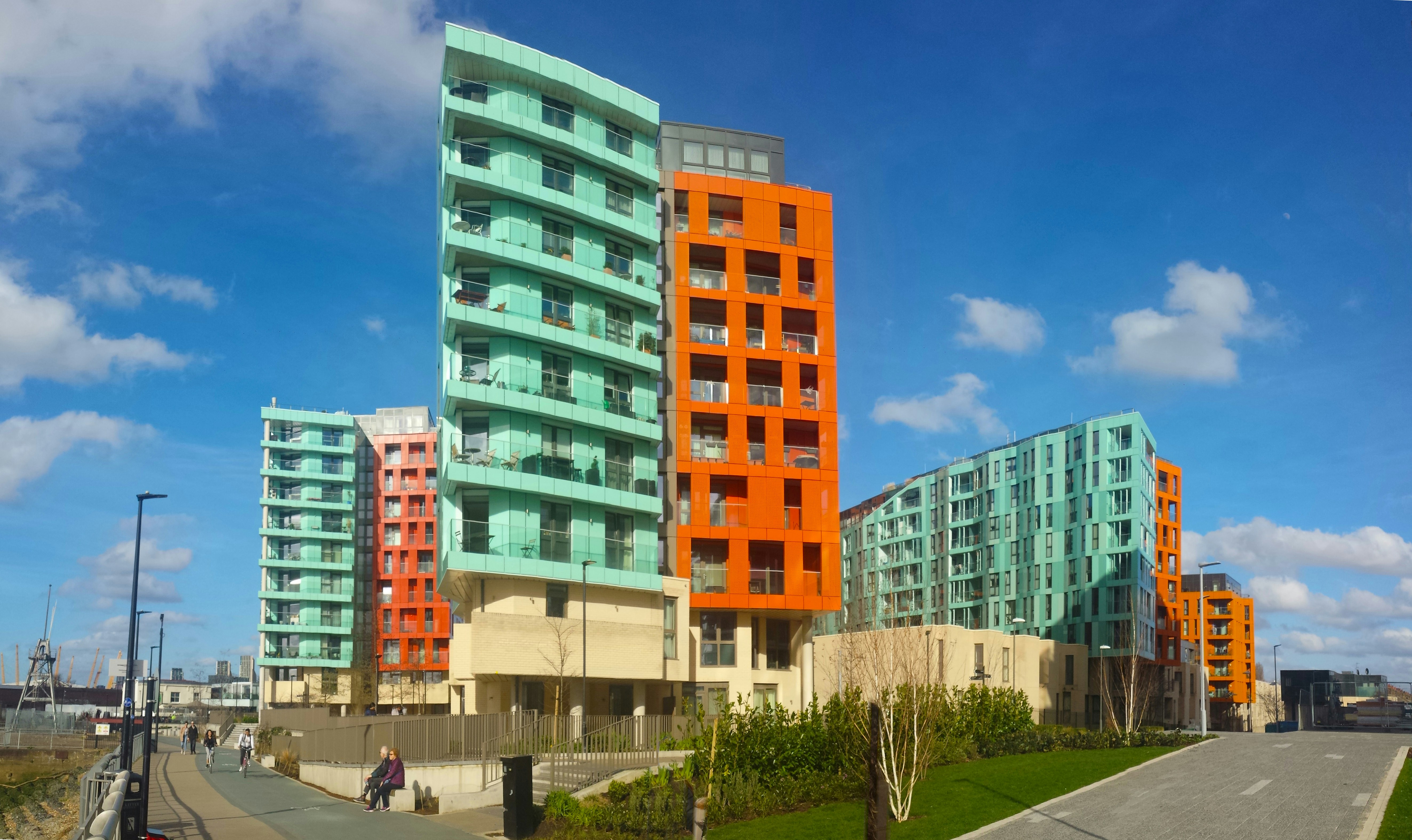 A row of multi - colored apartment buildings on a sunny day photo ...