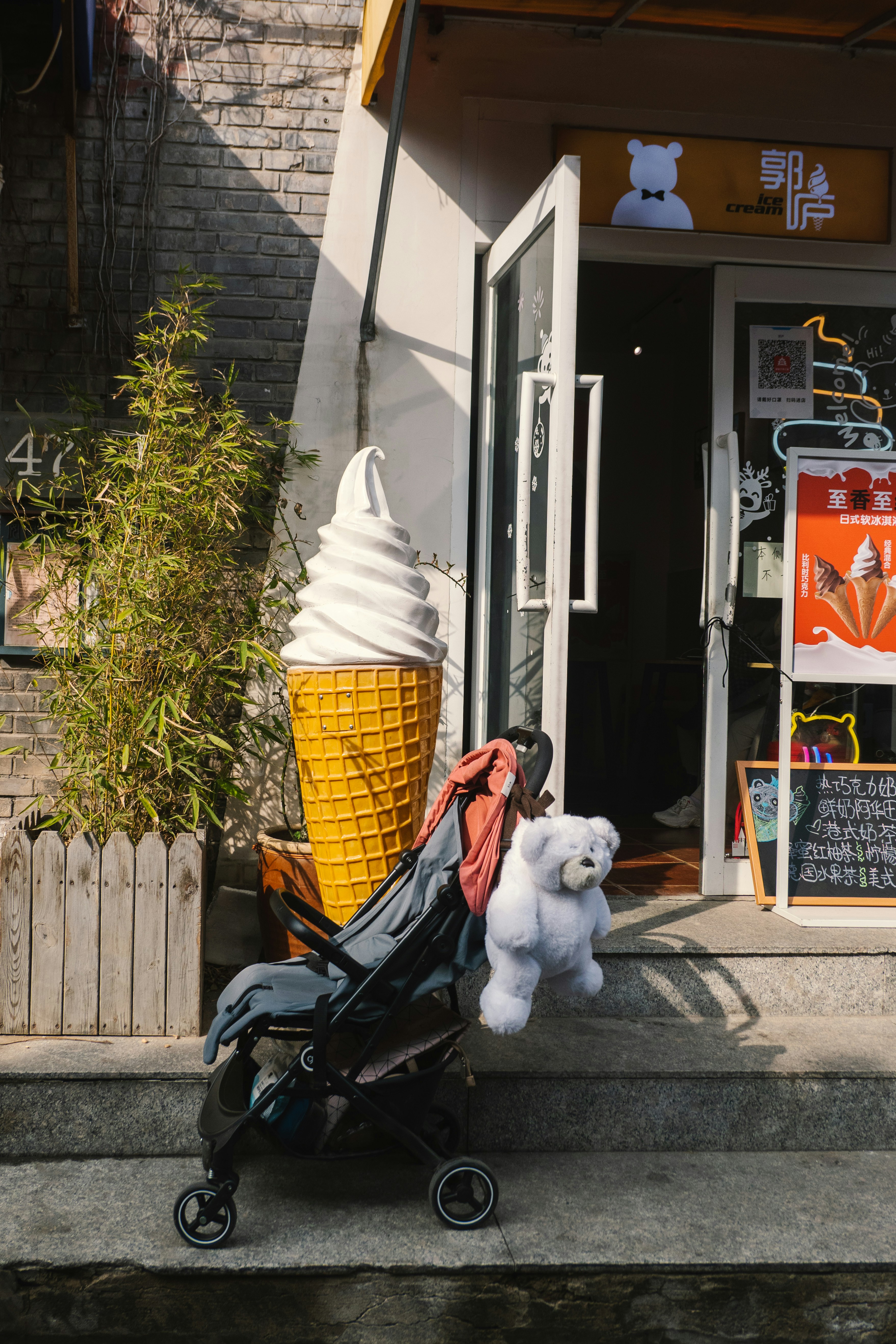 Stroller Stop at the Sweet Shop: A Toy Teddy Hangs by the Ice Cream Cone