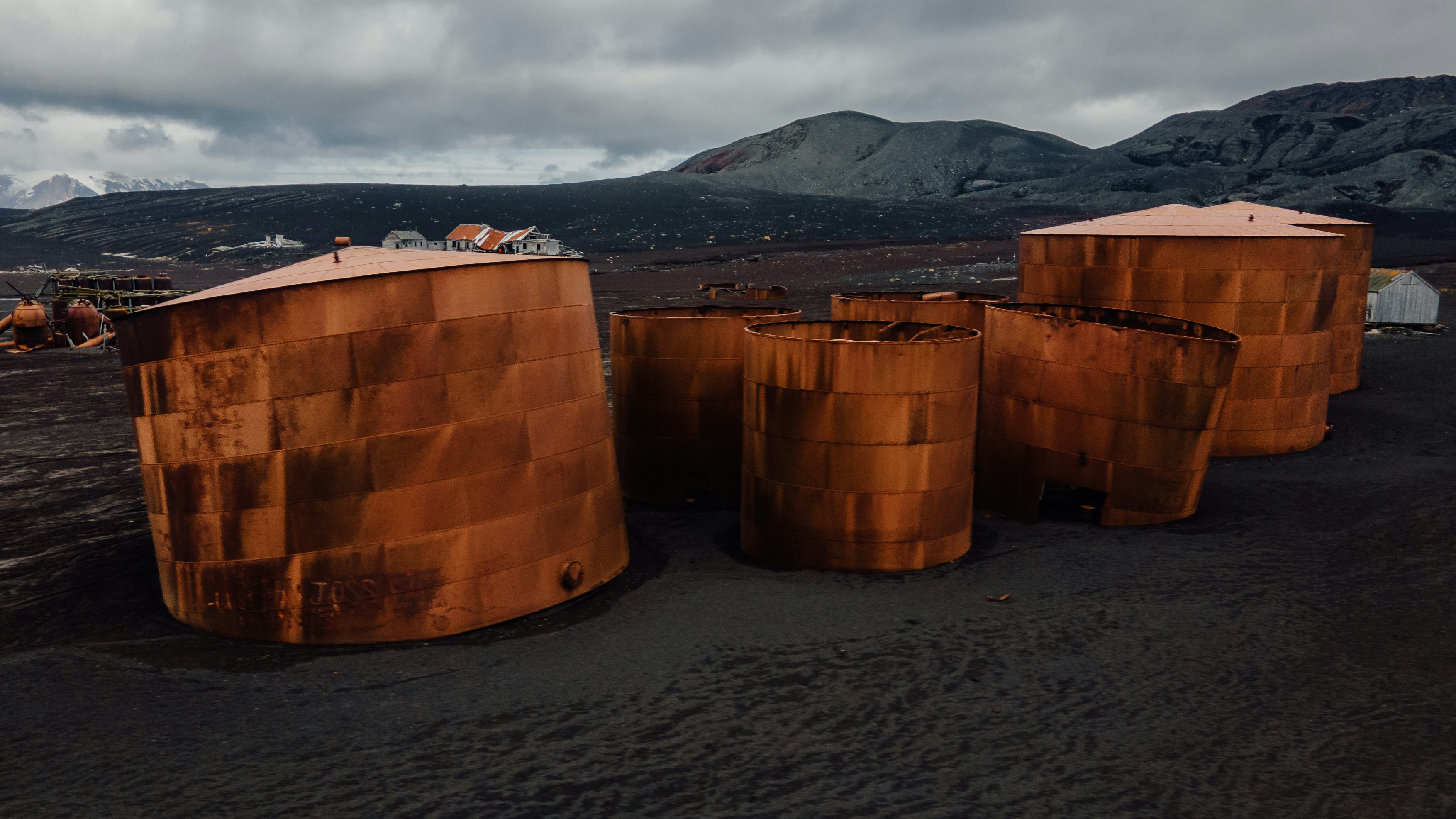 Rust-Colored Cylinders Guard a Black Sand Volcanic Field