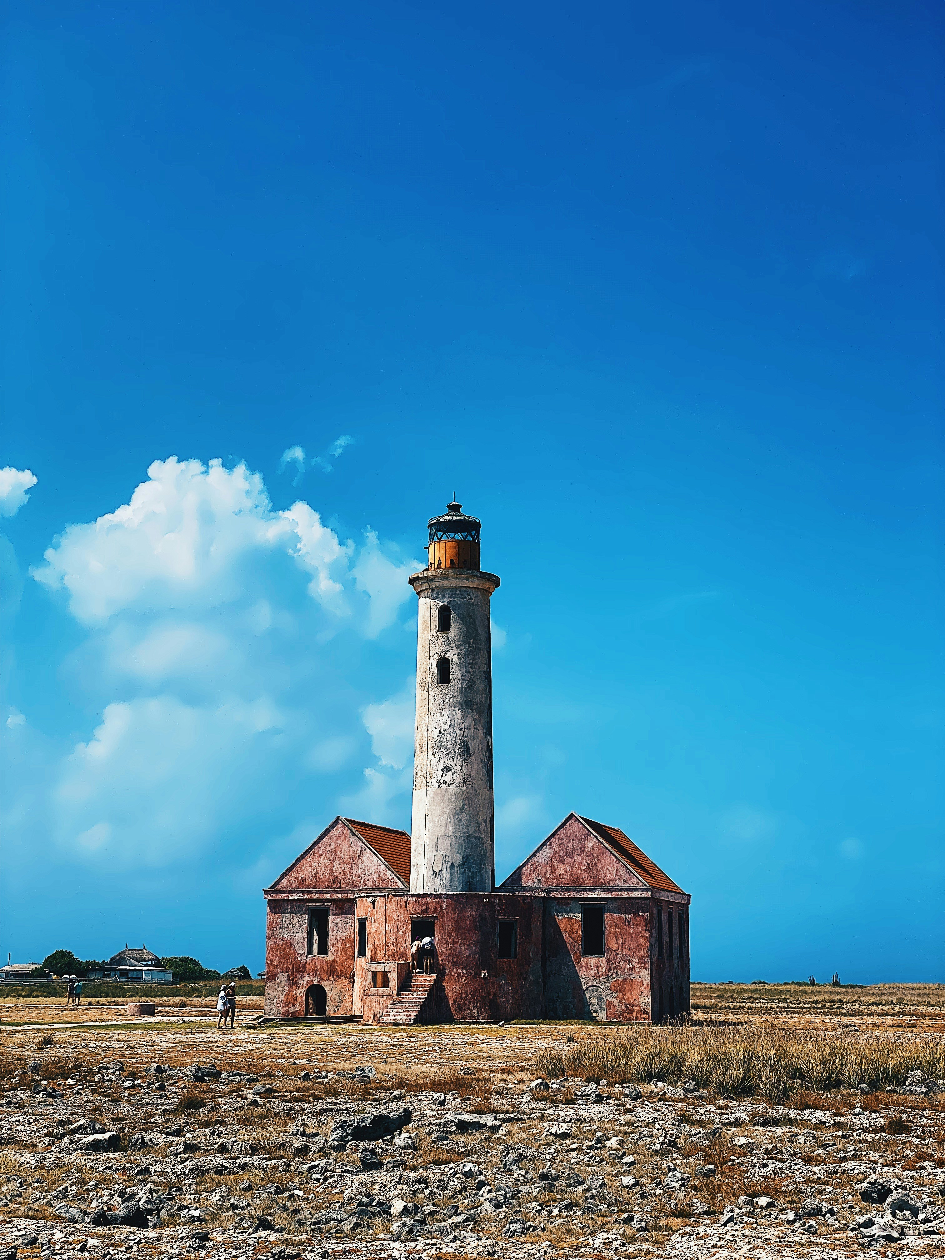 Lighthouse Sentinel on a Sunwashed Plain Under a Bold Blue Sky