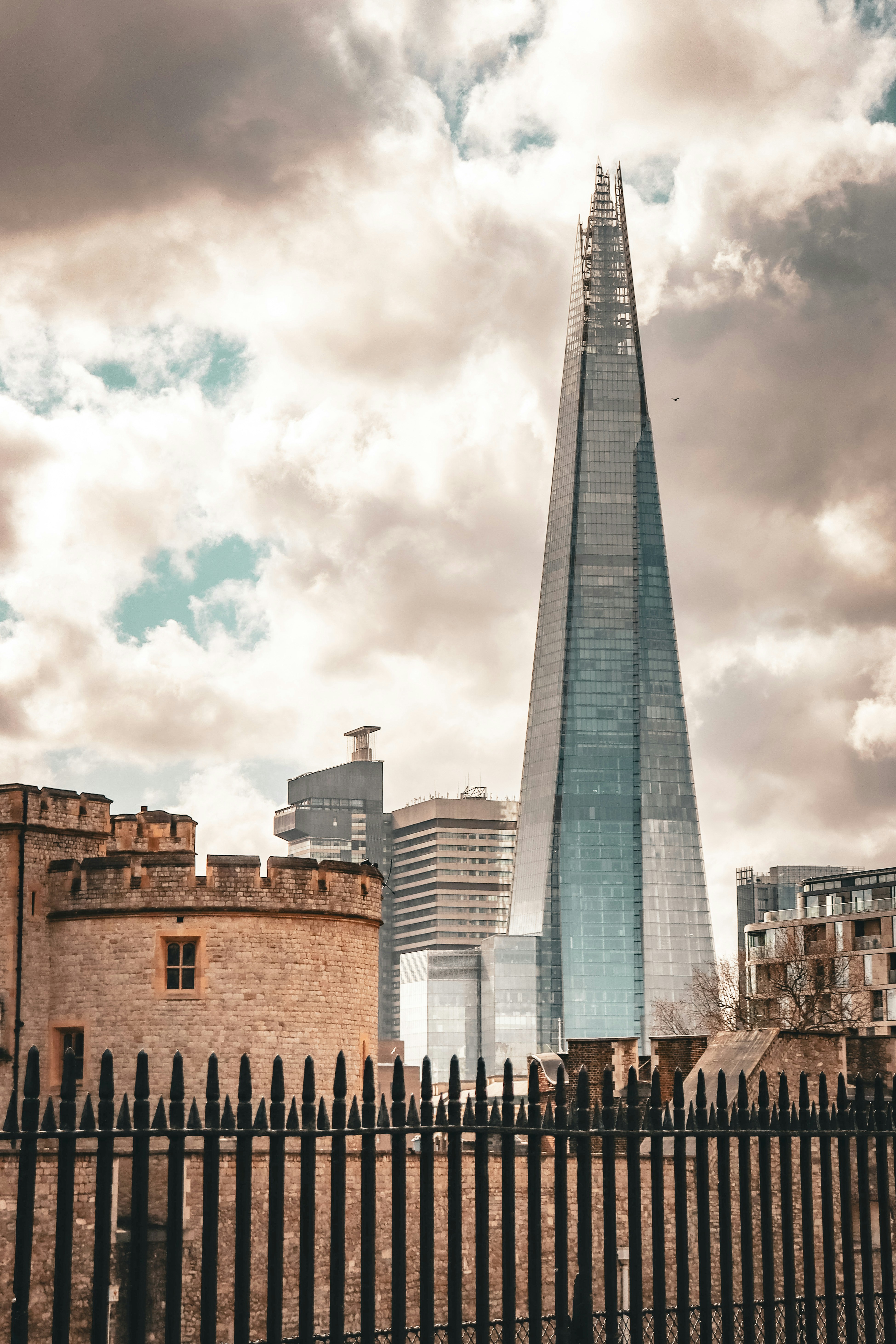 Contrasting Eras: A Modern Pinnacle Over Ancient Walls