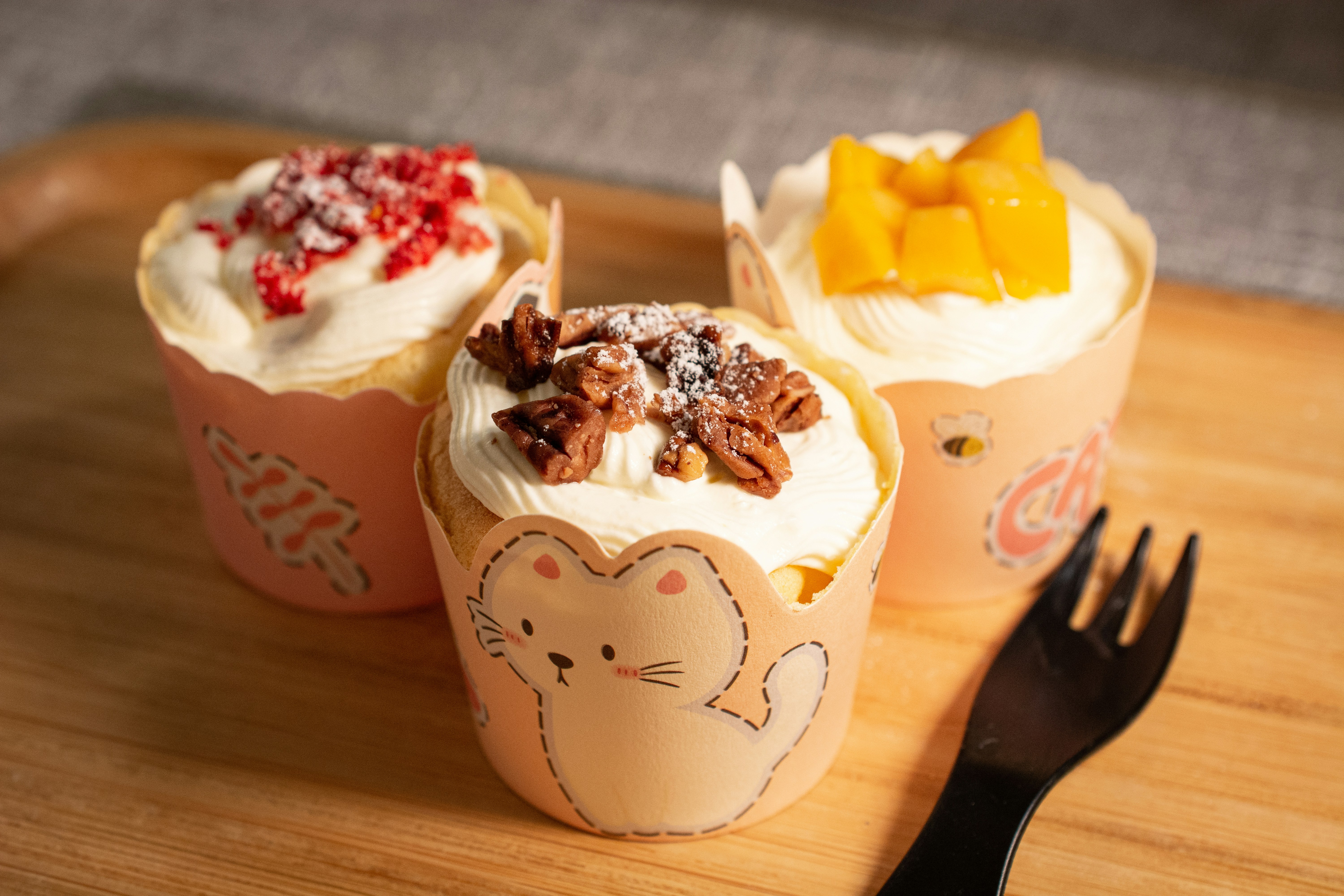 Pastel Cupcake Parade: Cat-Wrapped Treats with Mango, Nuts, and Berry Crumble