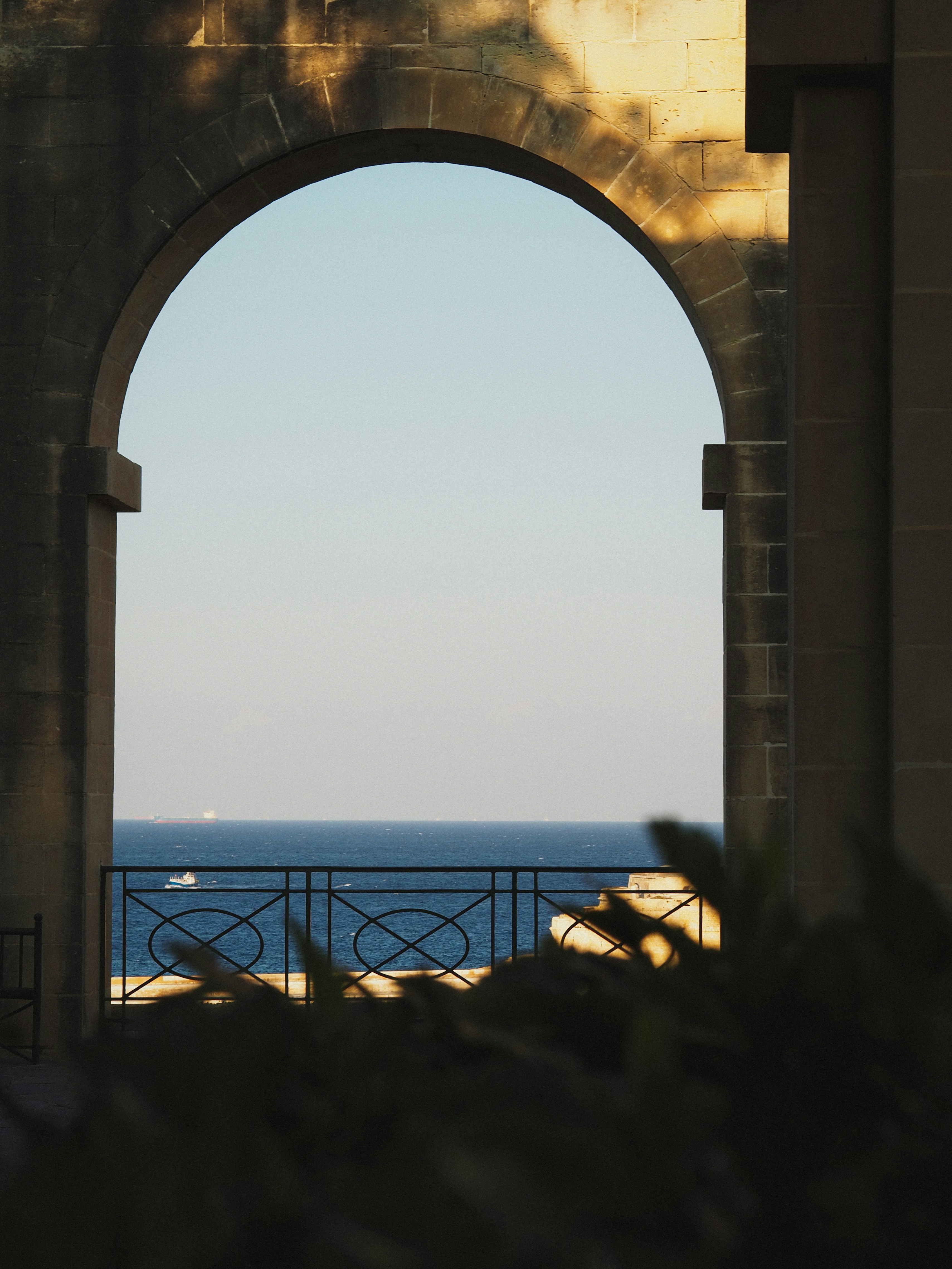 Archway Vista: Horizon Framed by Stone and Sea