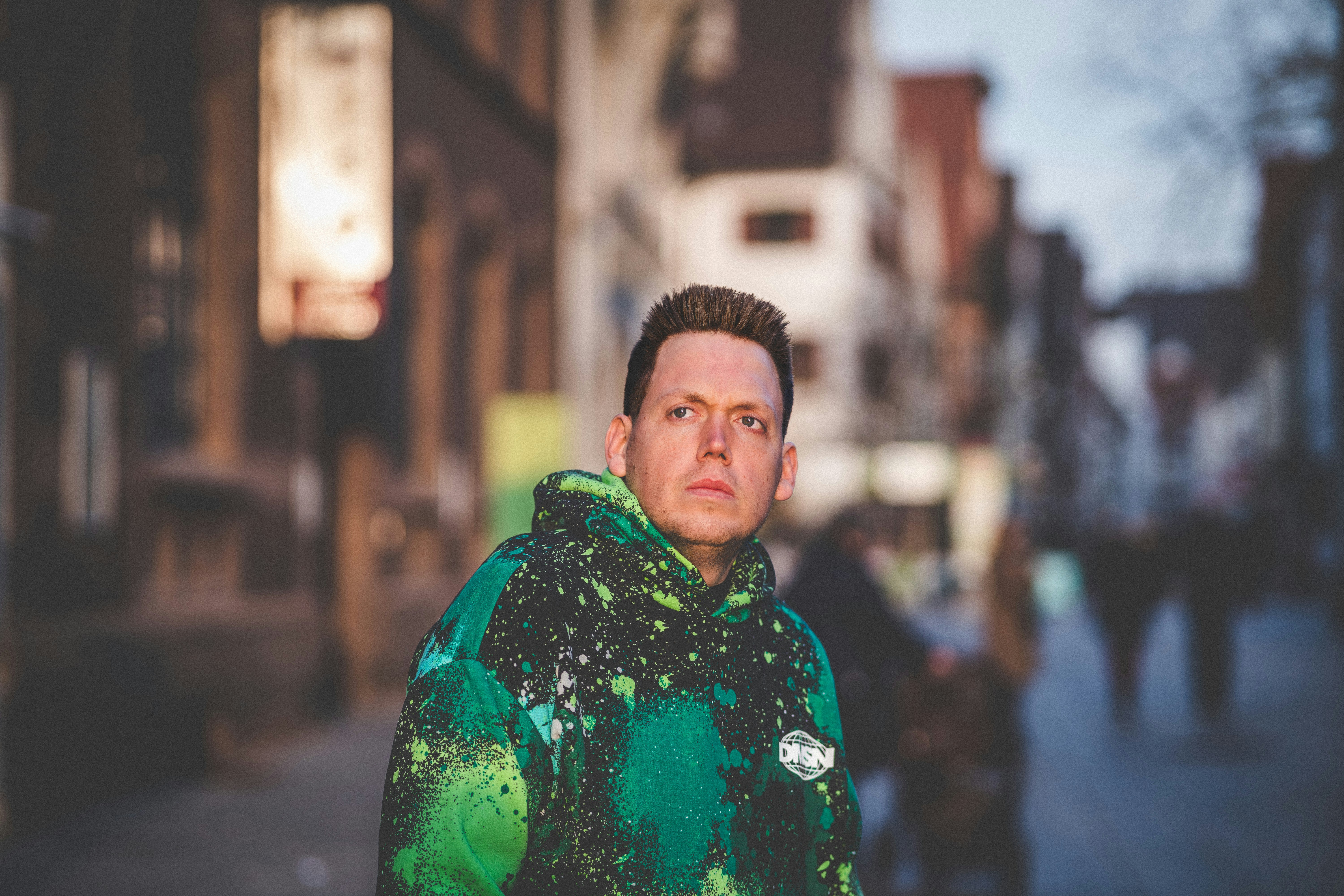 Green-speckled Dawn: A Focused Moment on a Street Portrait