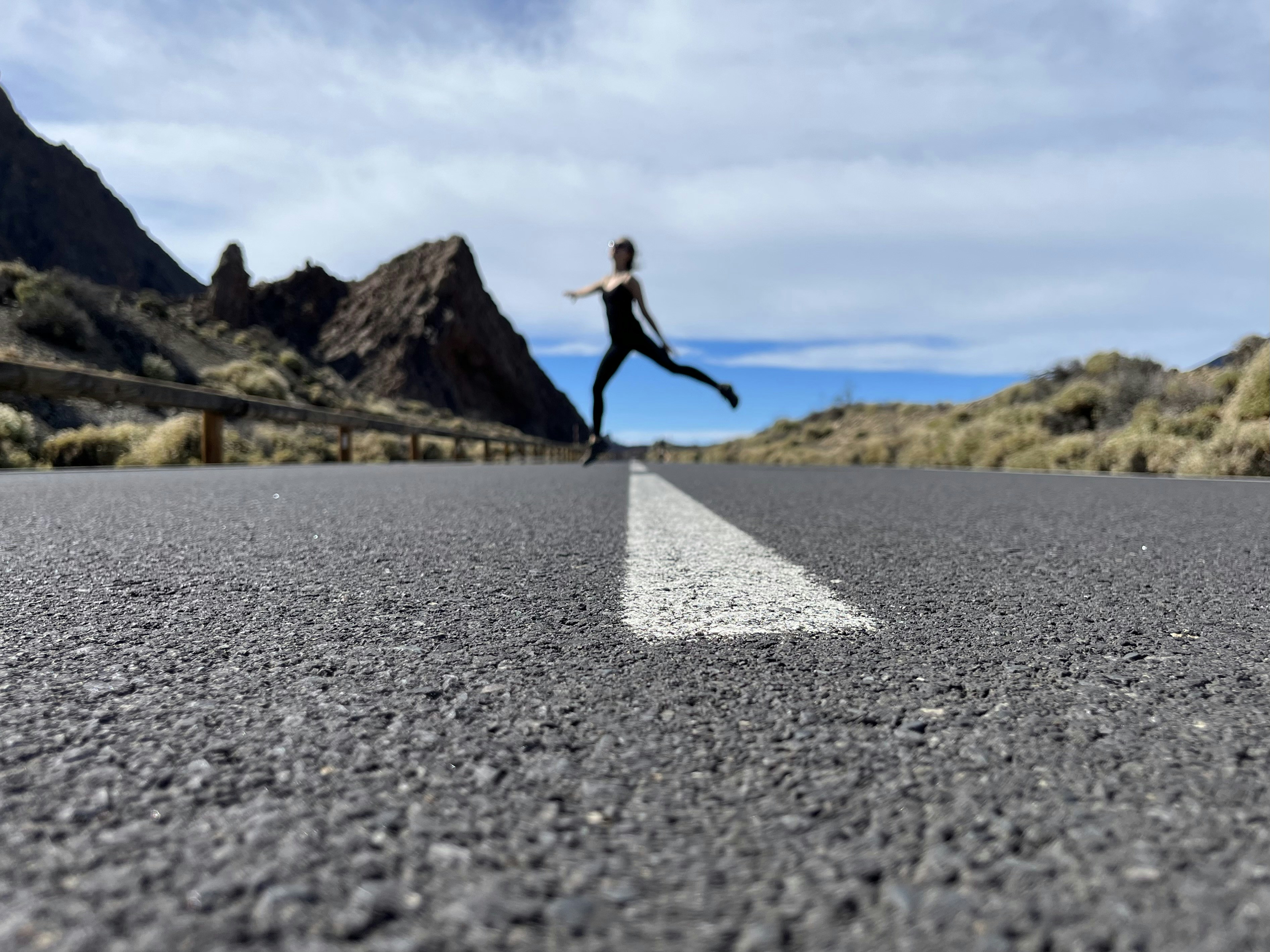 A woman is running down the road in the middle of nowhere photo – Free ...