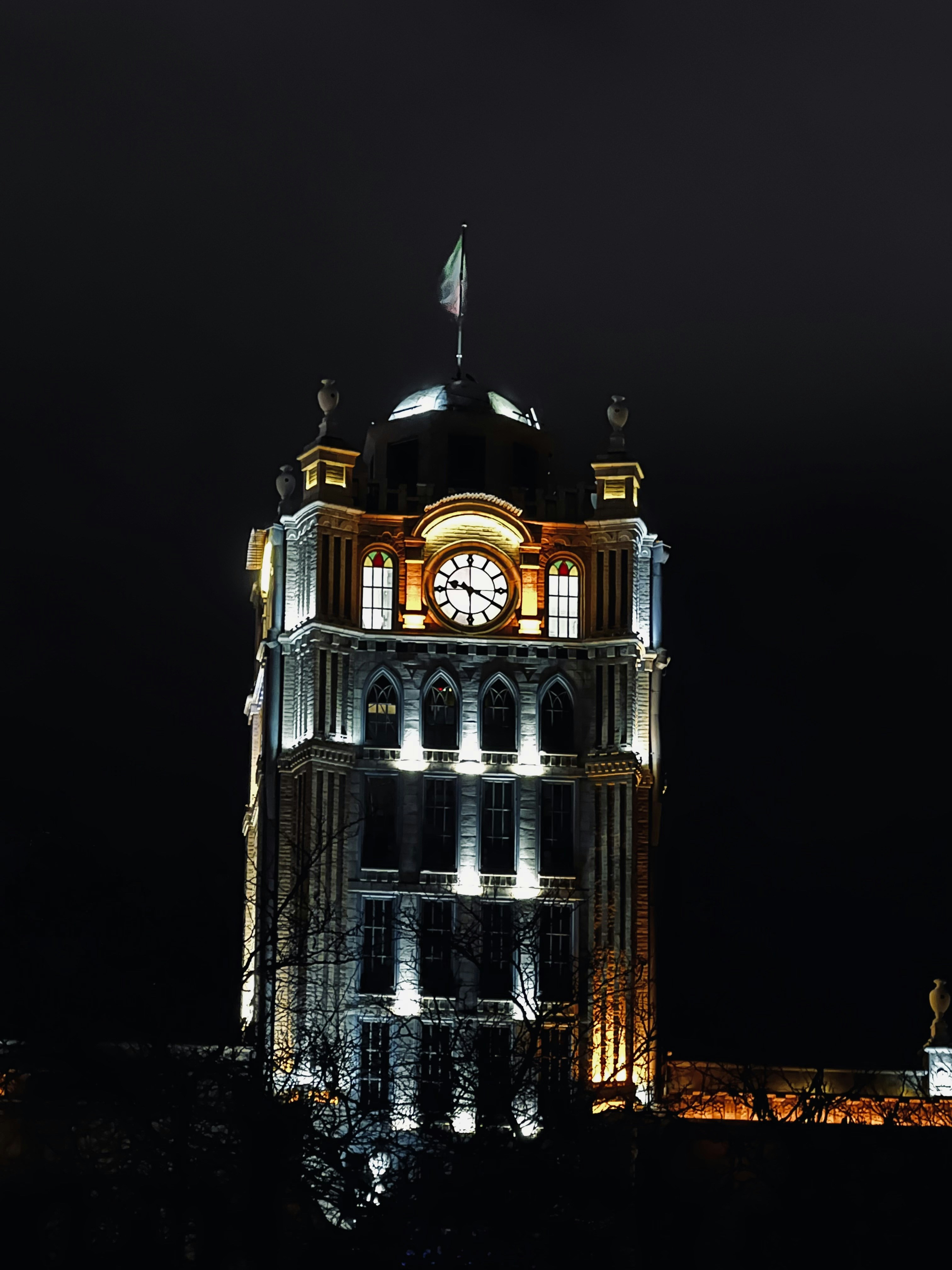A large clock tower lit up at night photo – Free Tabriz Image on Unsplash