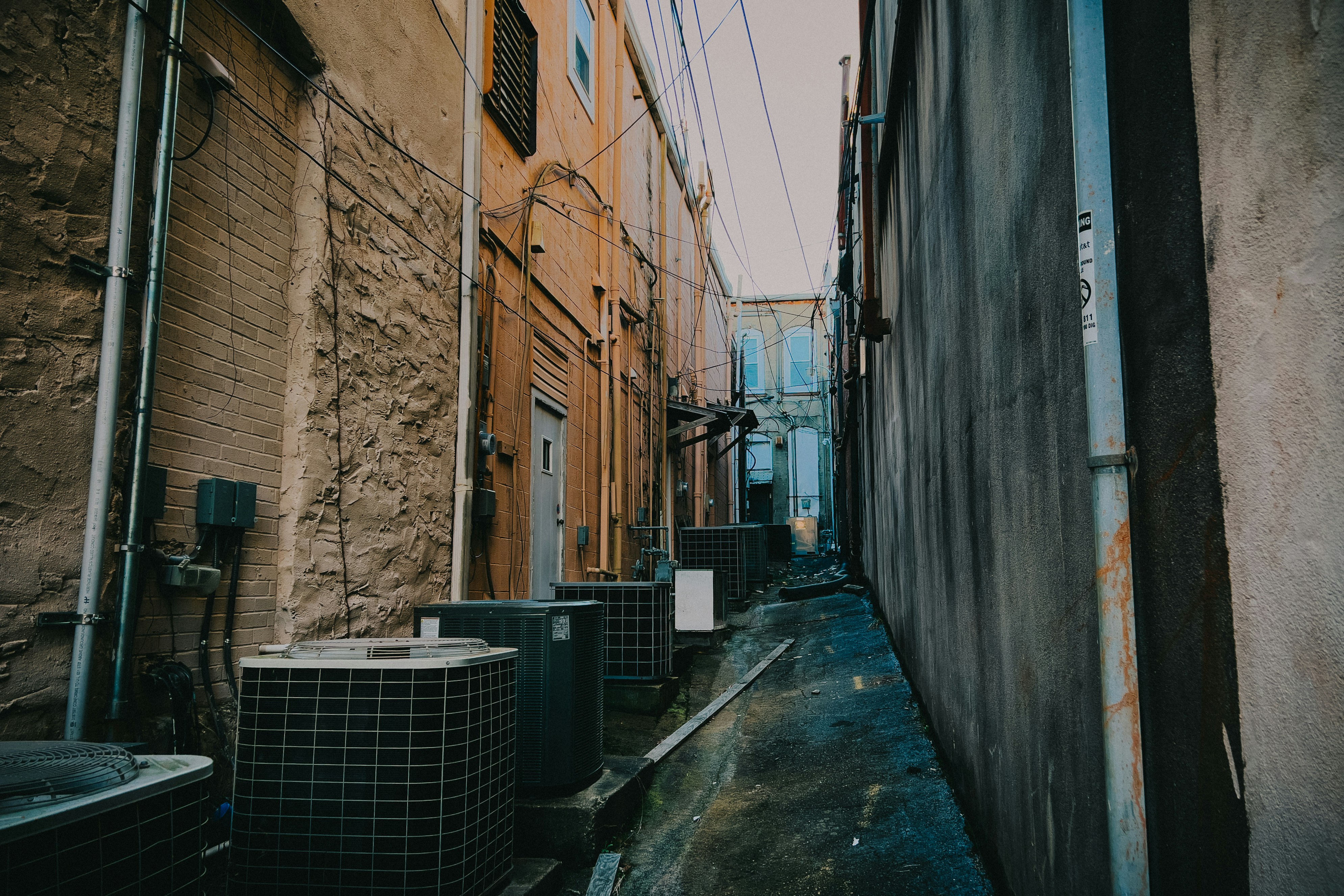 A narrow alley way with air conditioners on either side photo – Free ...