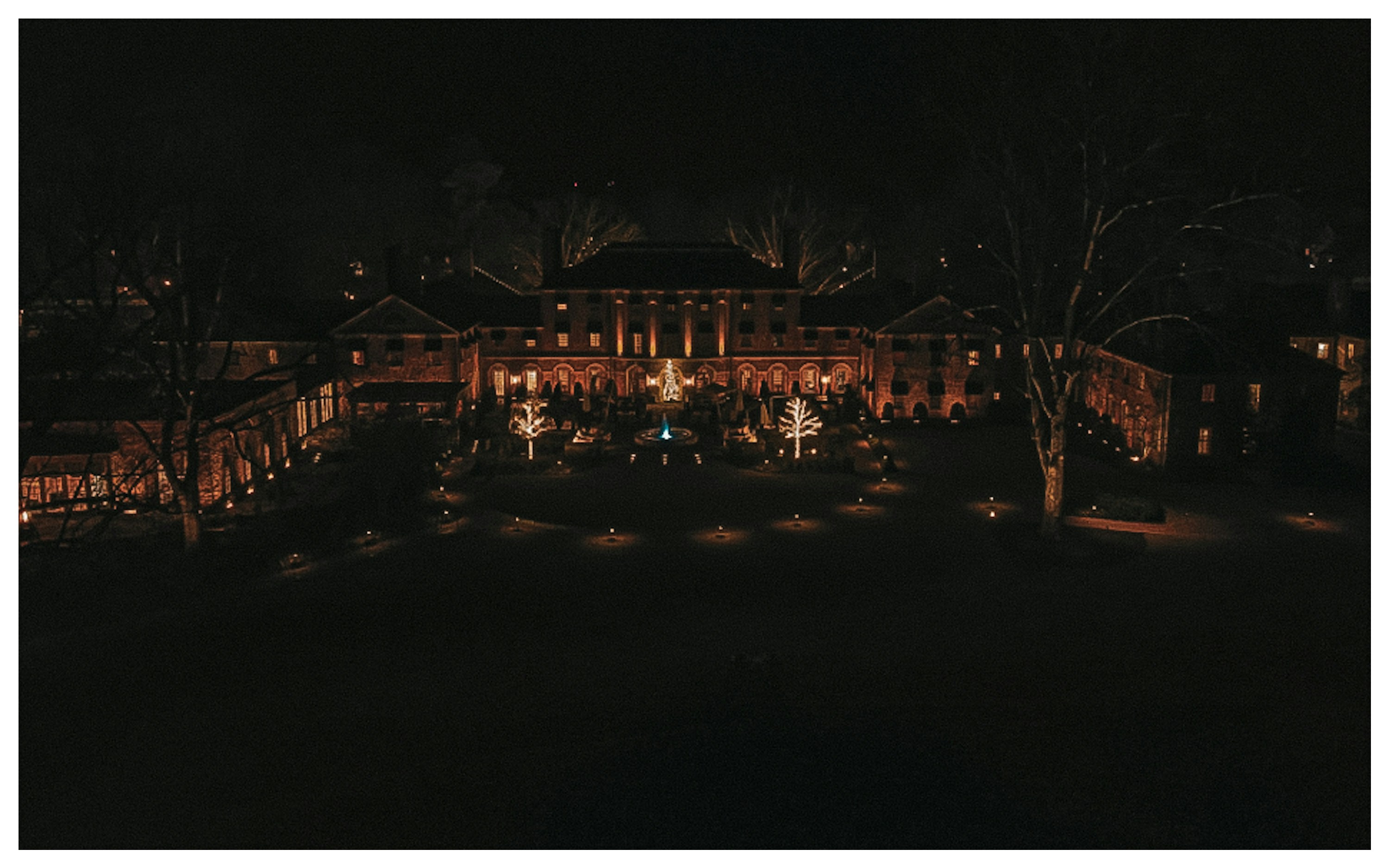 A mansion lit up at night with christmas lights photo – Free Building ...