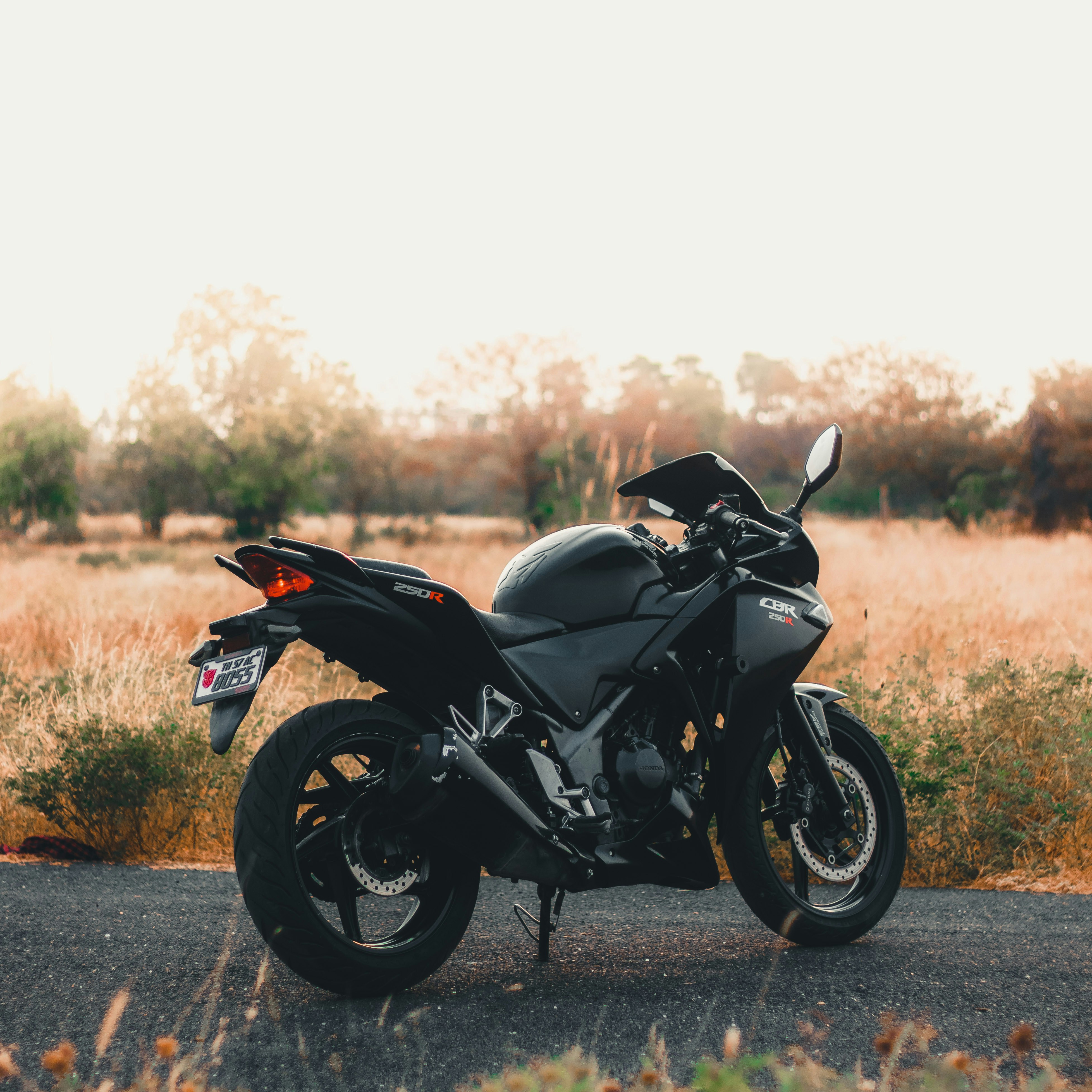 A black motorcycle parked on the side of a road photo – Free Honda cbr ...