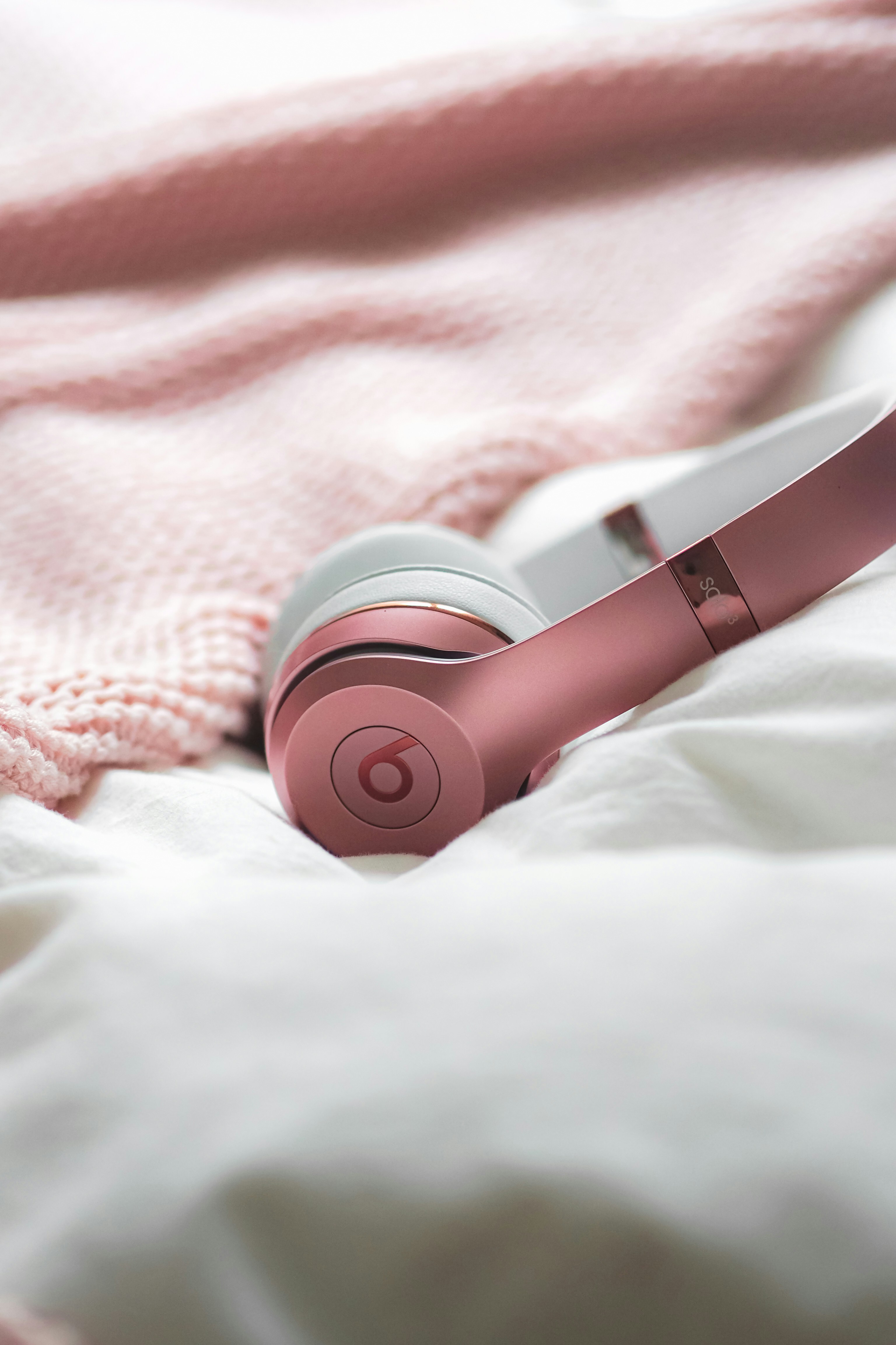 A pair of headphones laying on top of a bed photo – Free Electronics ...