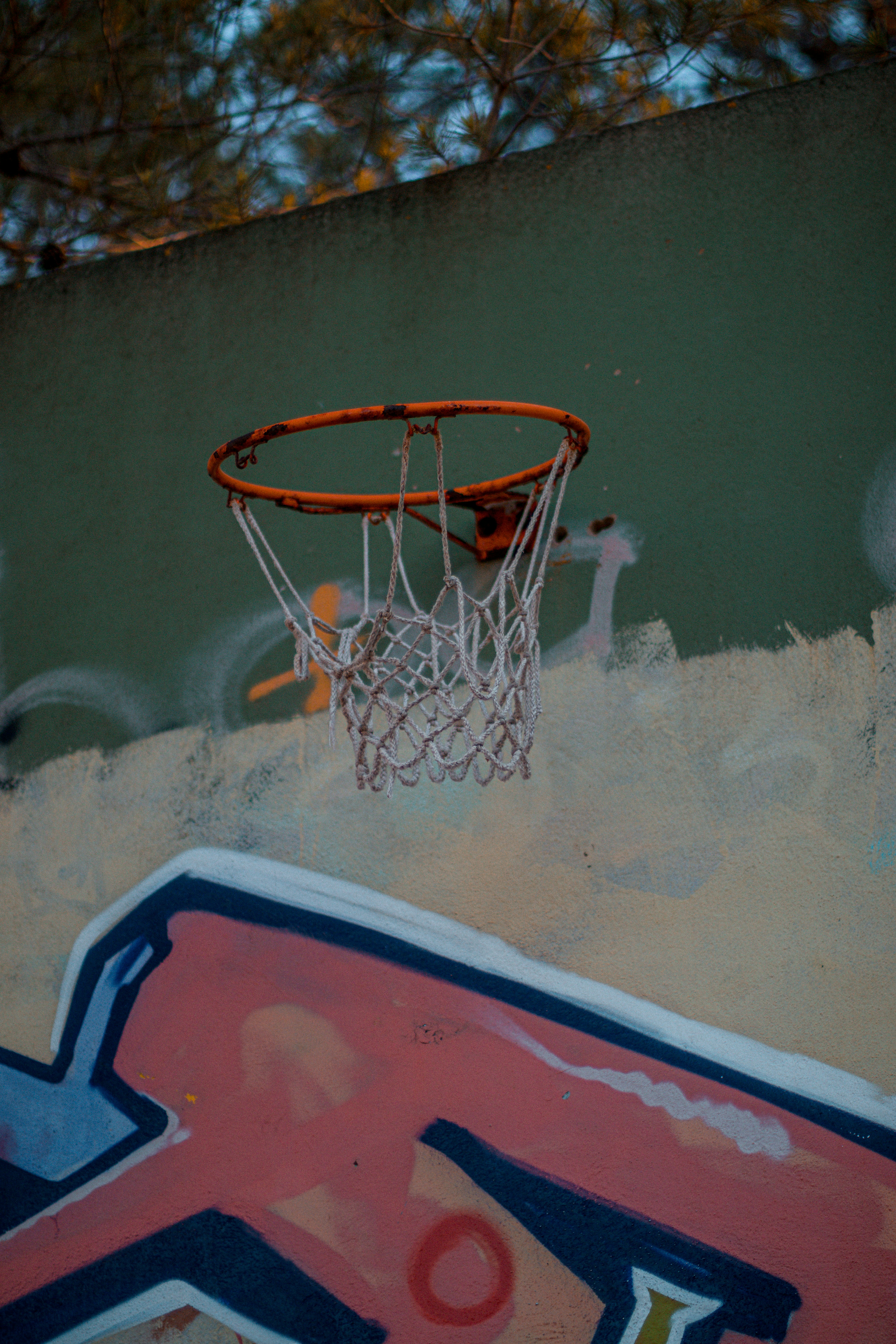 a basketball hoop hanging from the side of a wall