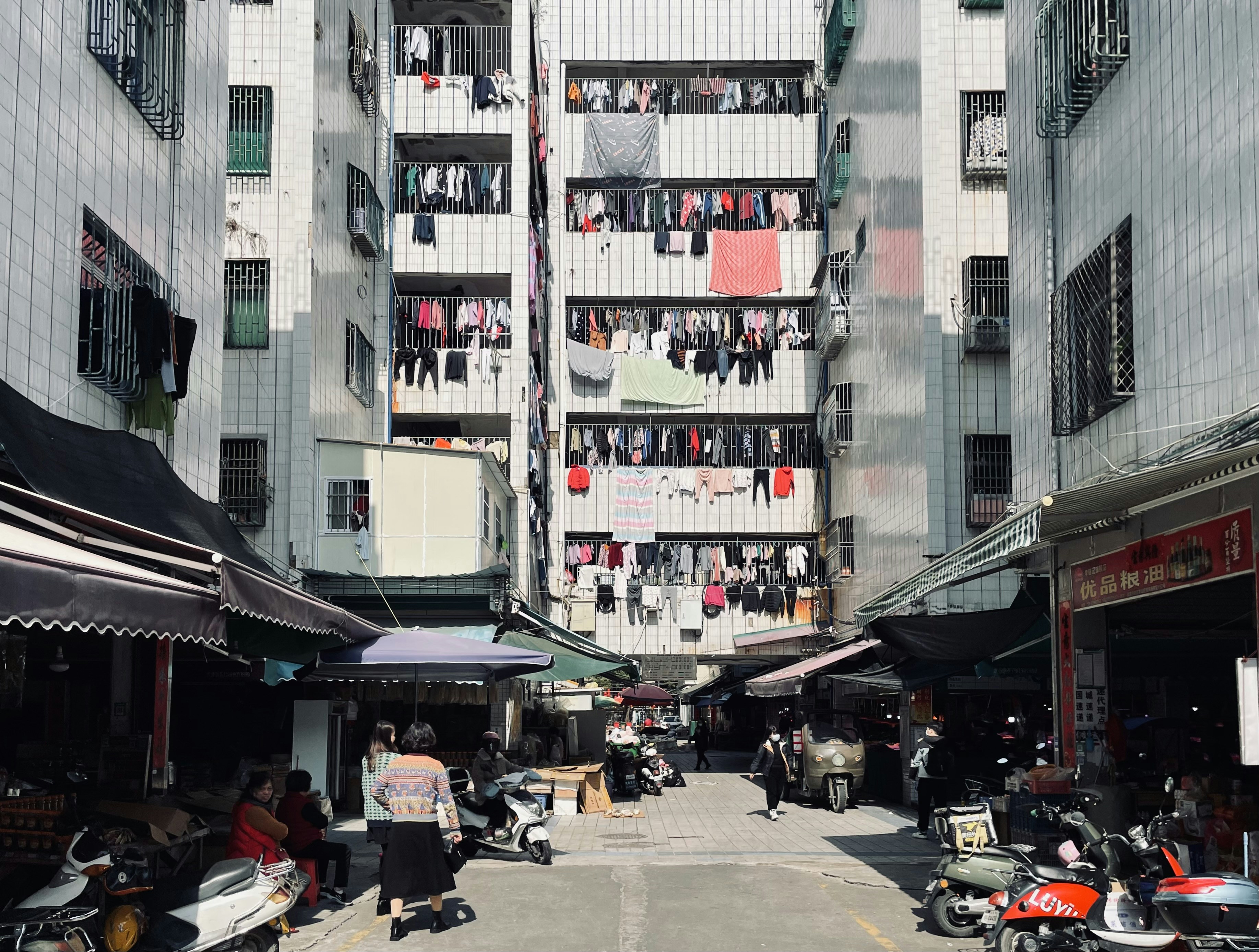 A narrow city street lined with tall buildings photo – Free Street ...