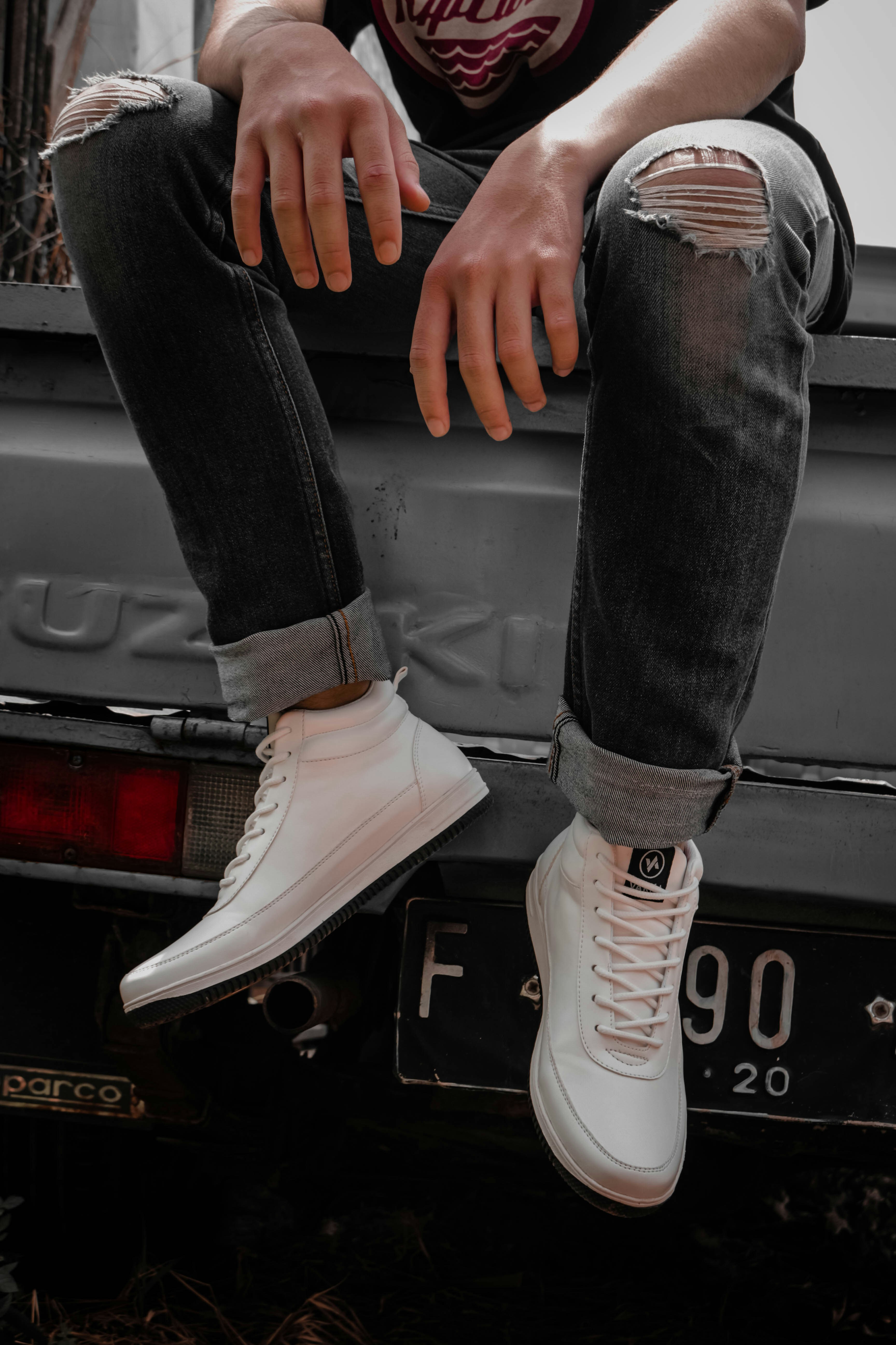 White Sneakers on a Weathered Tailgate: A Quiet Street Moment