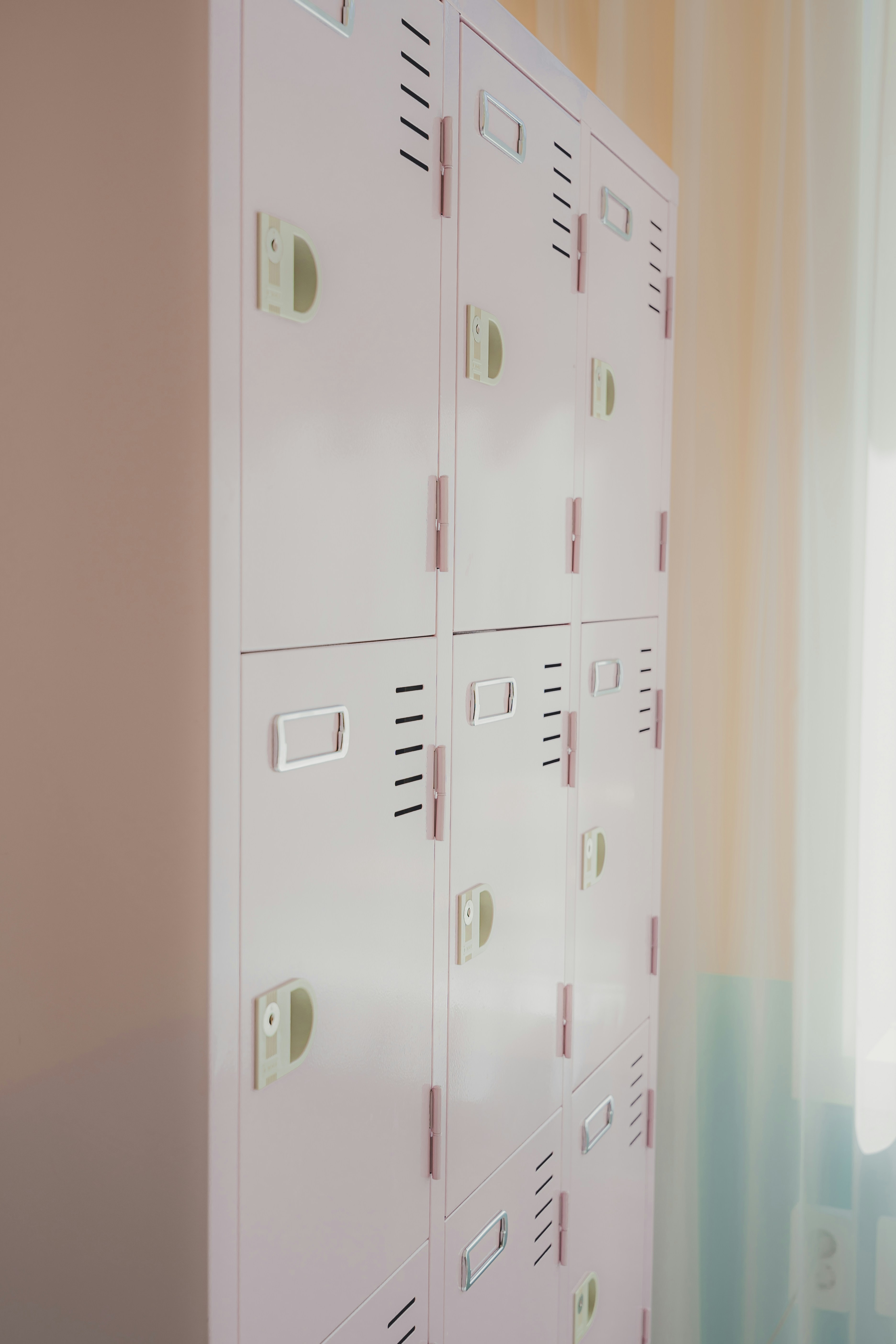 A row of white lockers sitting next to a window photo – Free Grey Image ...