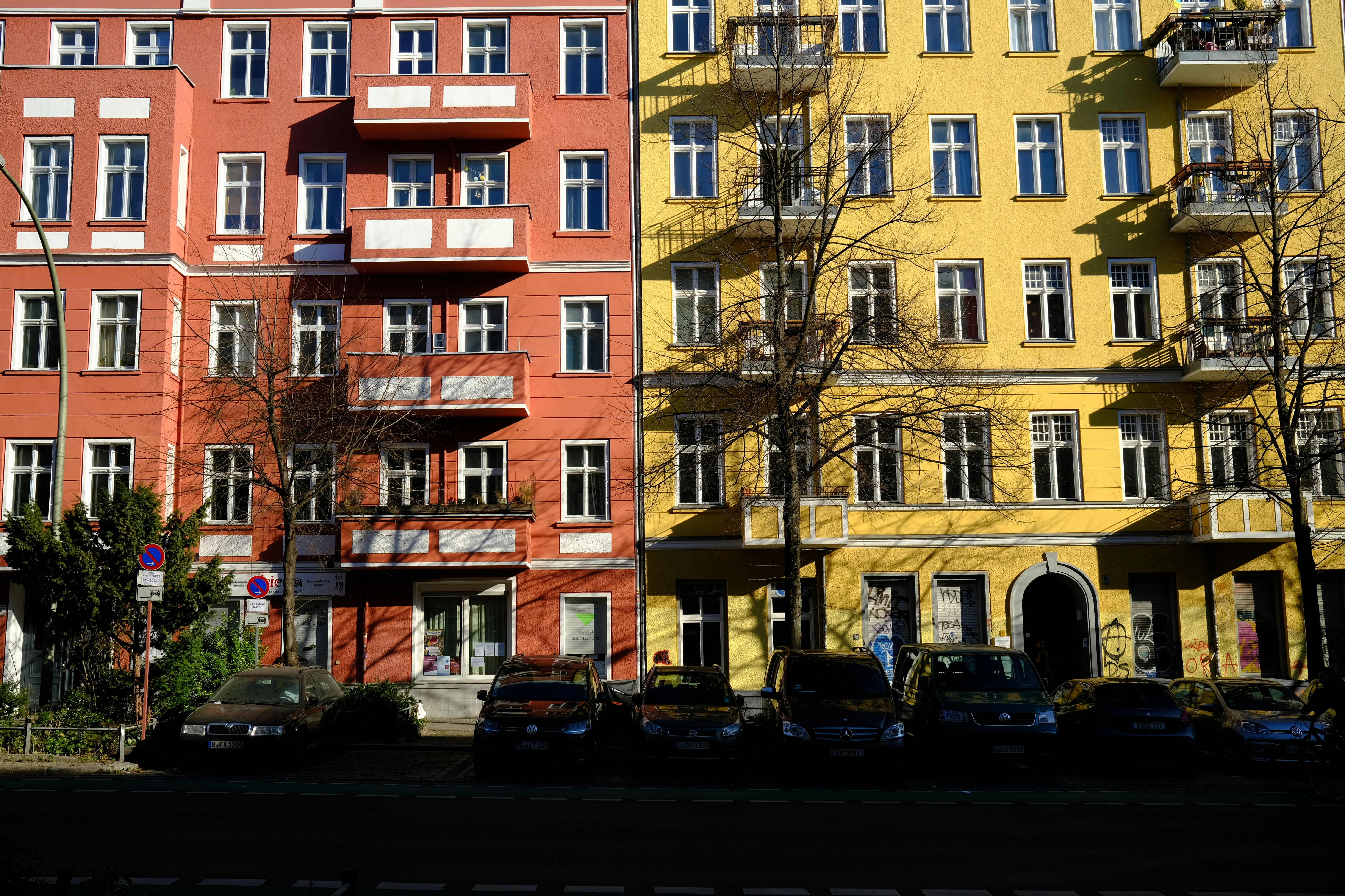 A row of multi - colored apartment buildings next to each other photo ...