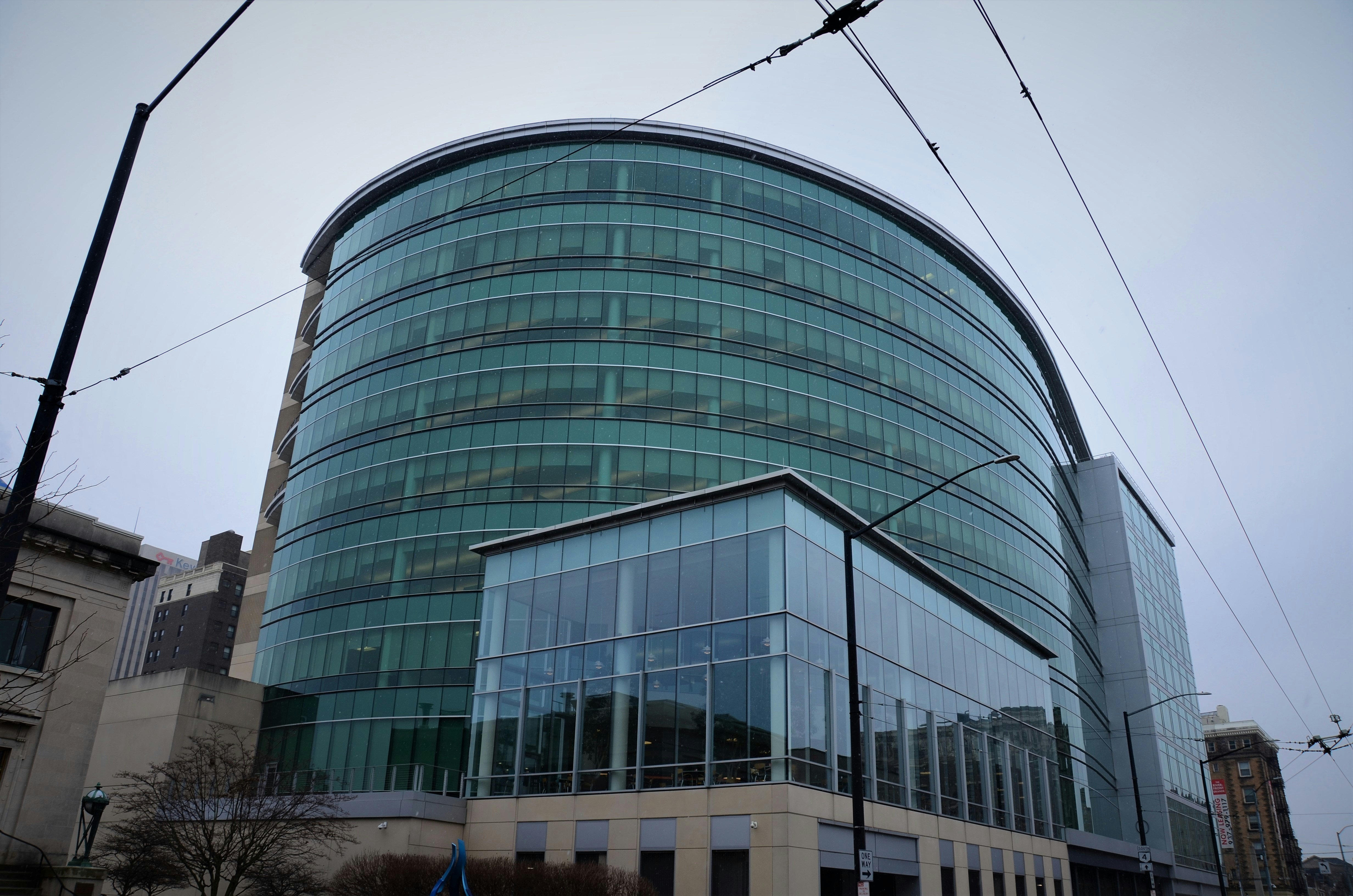 A large glass building sitting next to a street photo – Free Grey Image ...