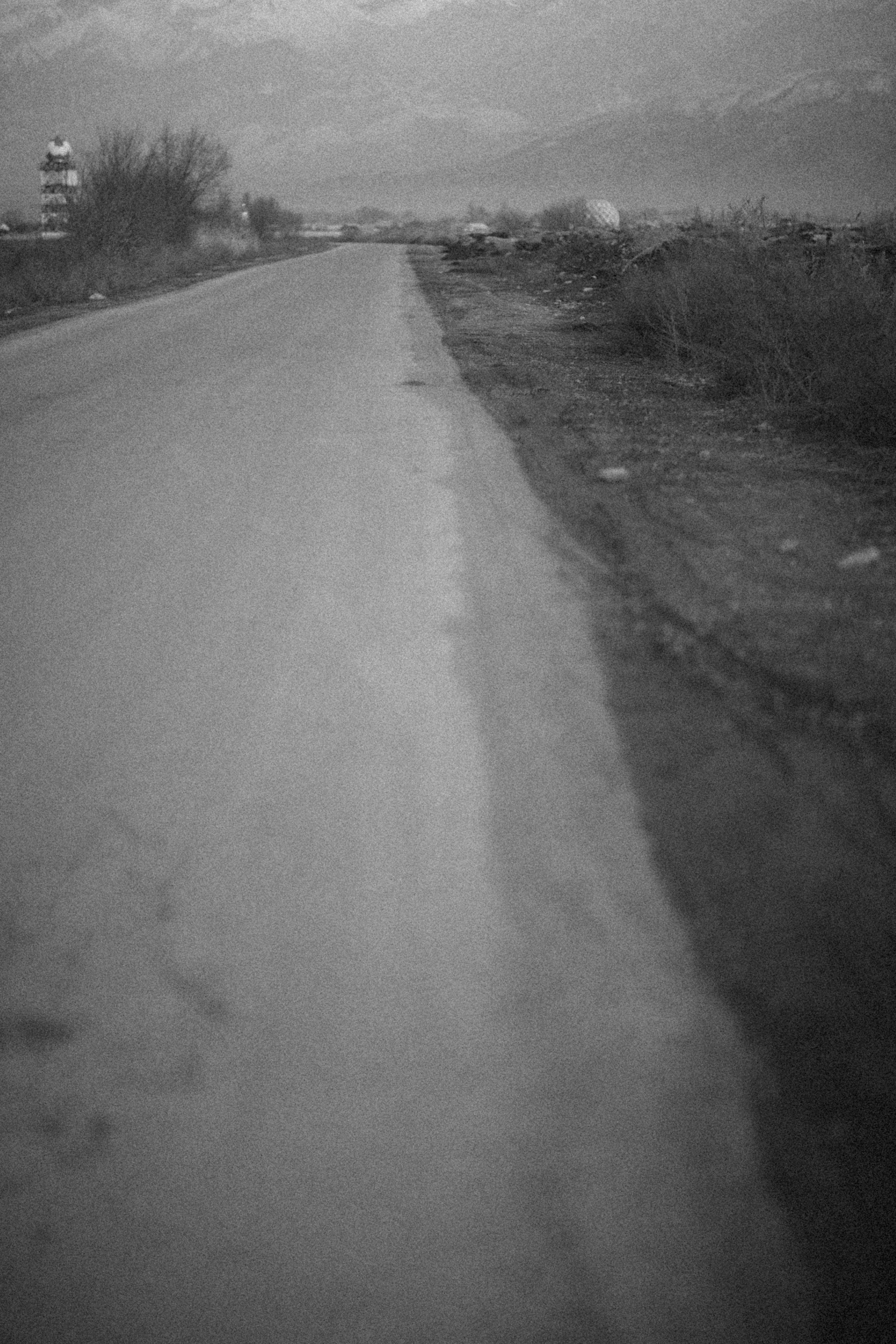 a black and white photo of a deserted road