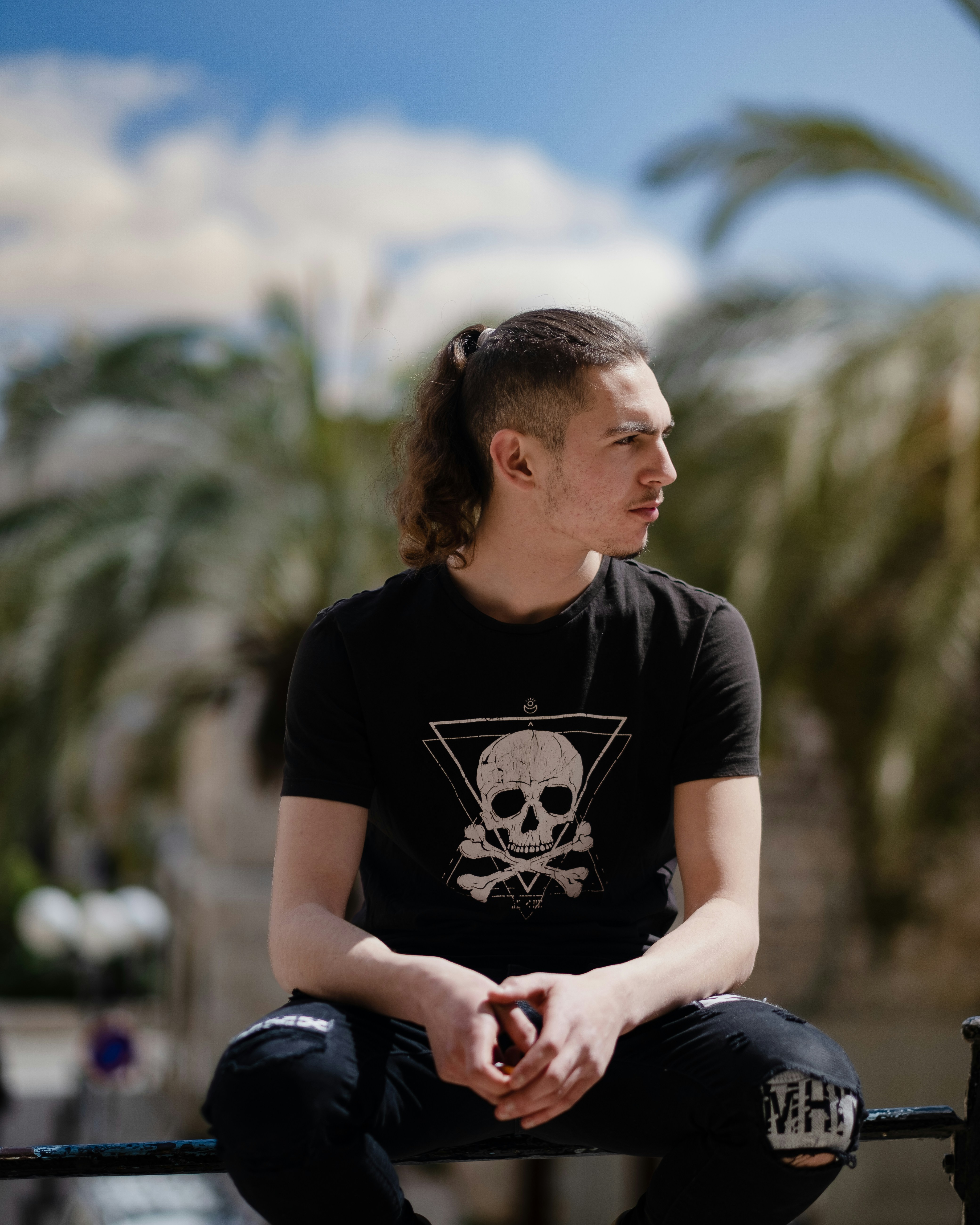 Afternoon Quiet Under Palms: Portrait of a Man in a Skull Tee