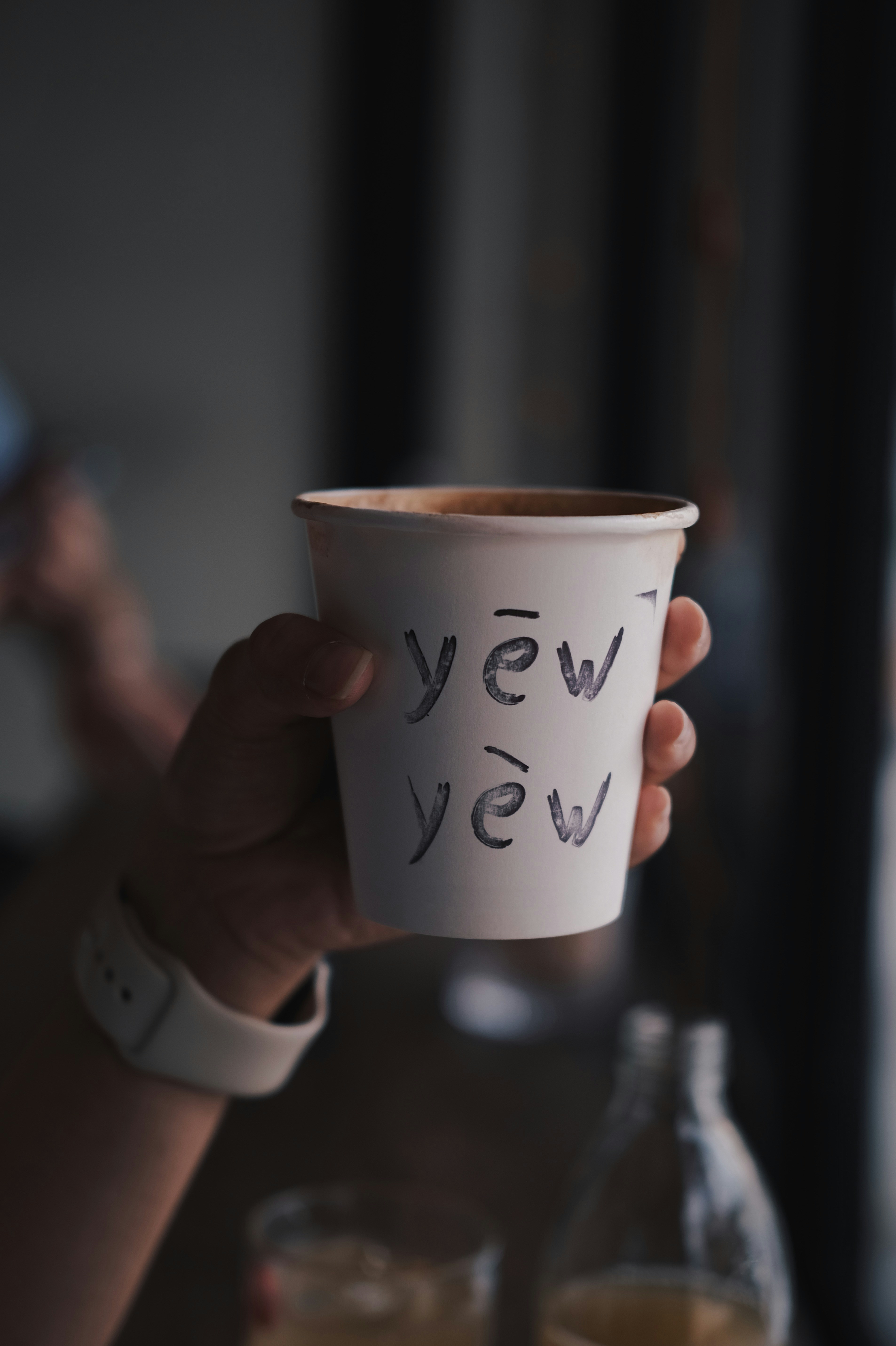 Cup of Quiet Moments: Handheld Coffee with Scribbled 'yew yew'