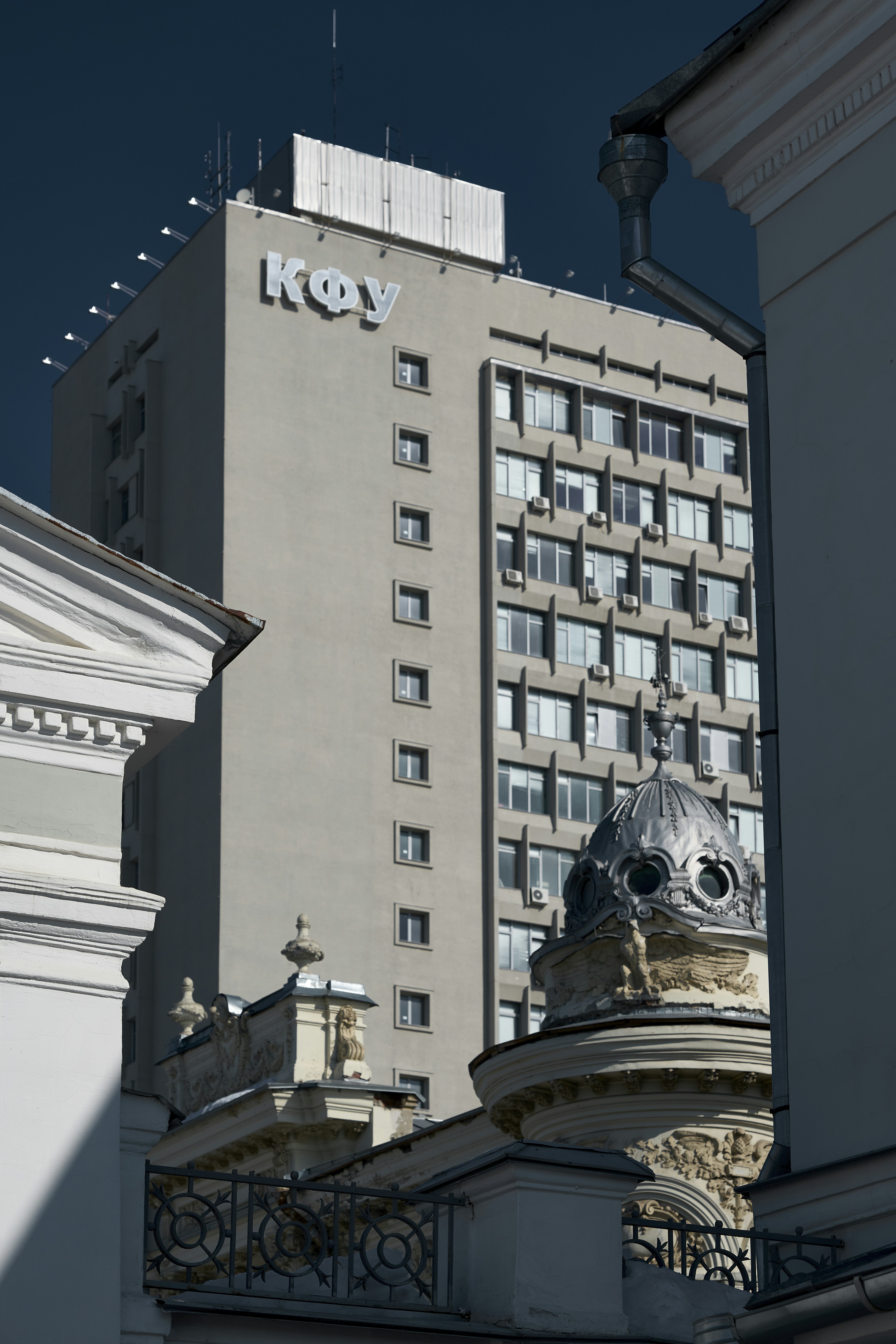 A tall building with a sky scraper in front of it photo – Free Building ...