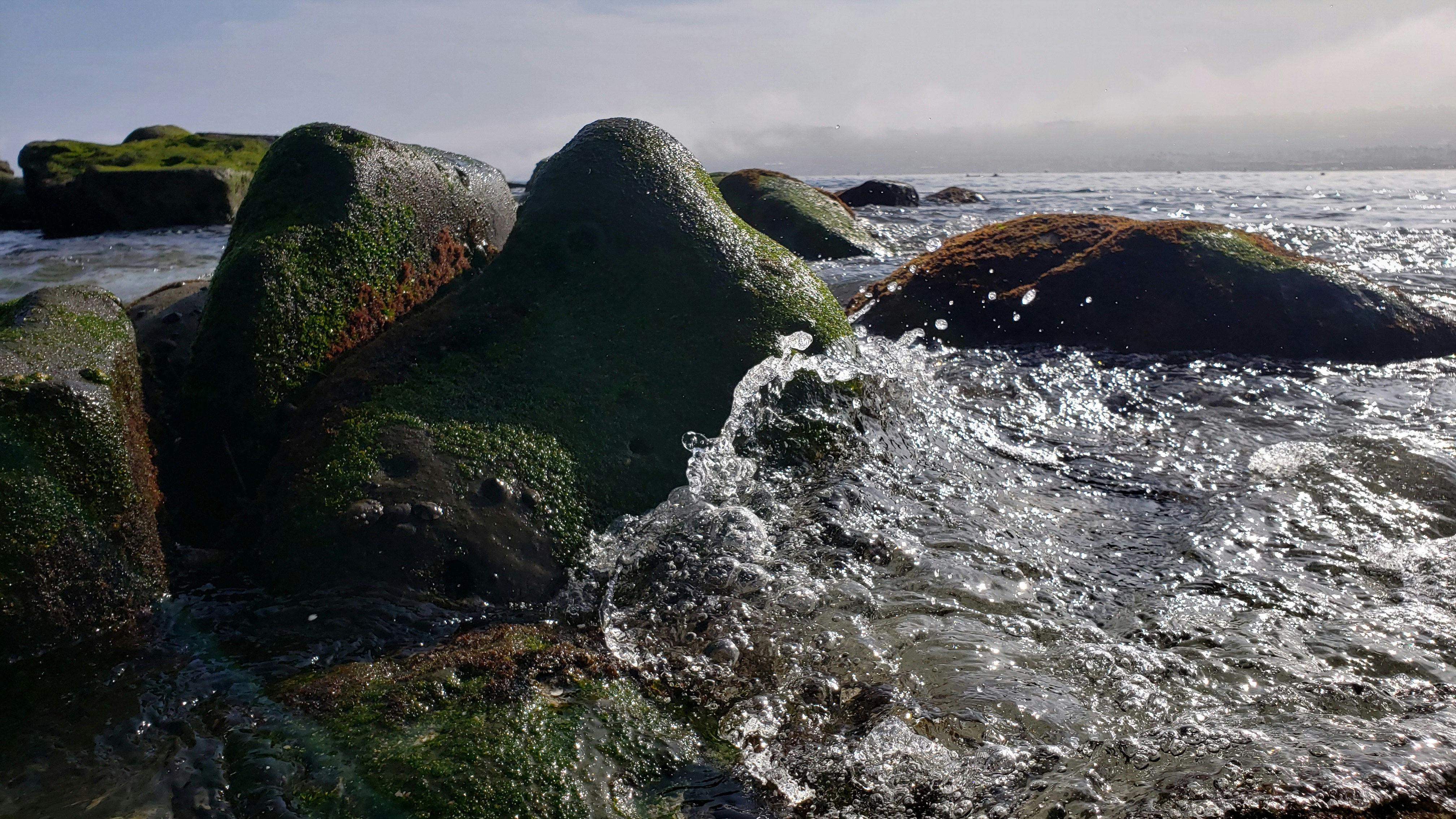 Shot of some small waves hitting rocks at La Jolla Cove near San Diego, California.