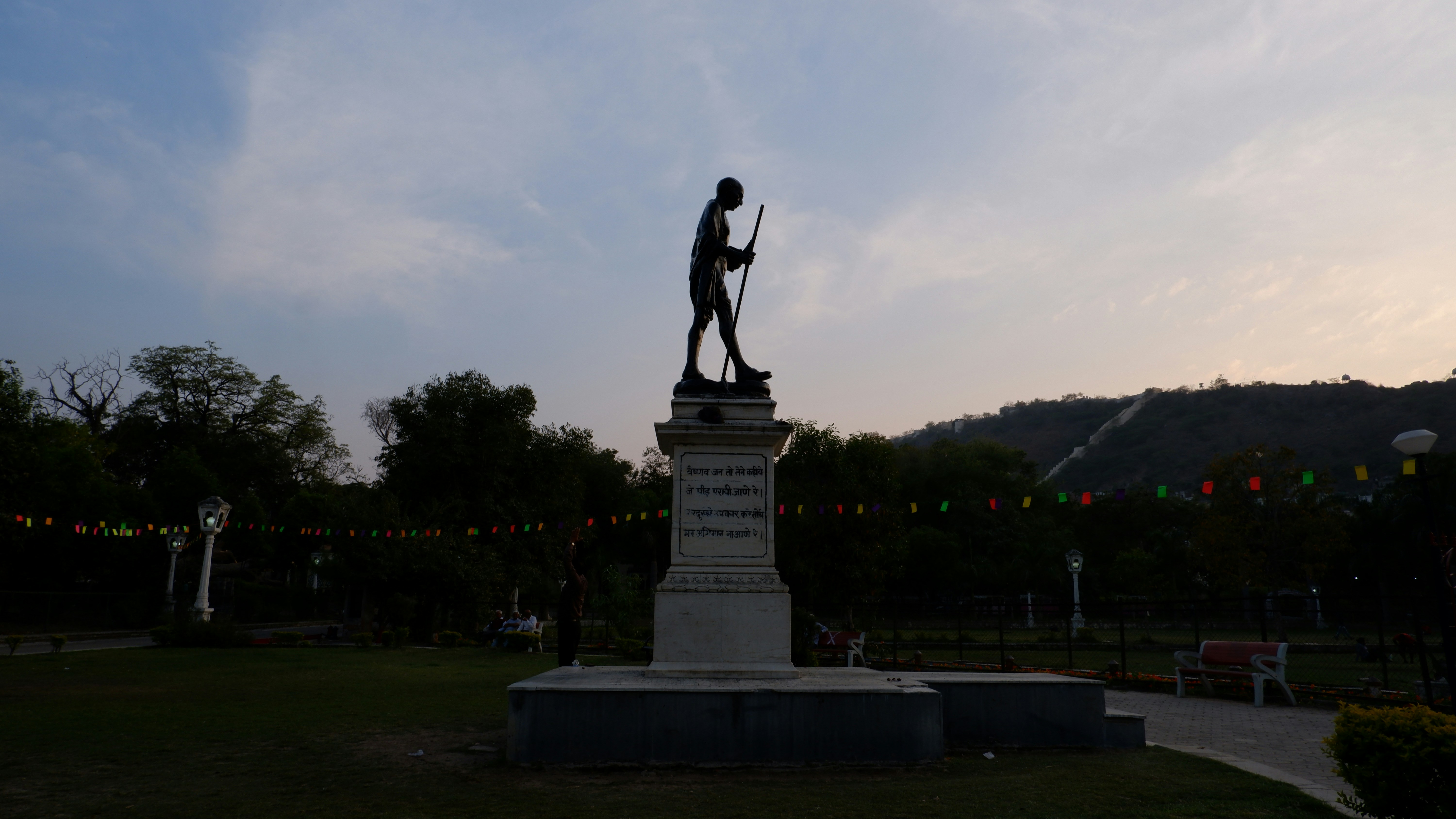 A statue of a man holding a cane in a park photo – Free Grey Image on ...