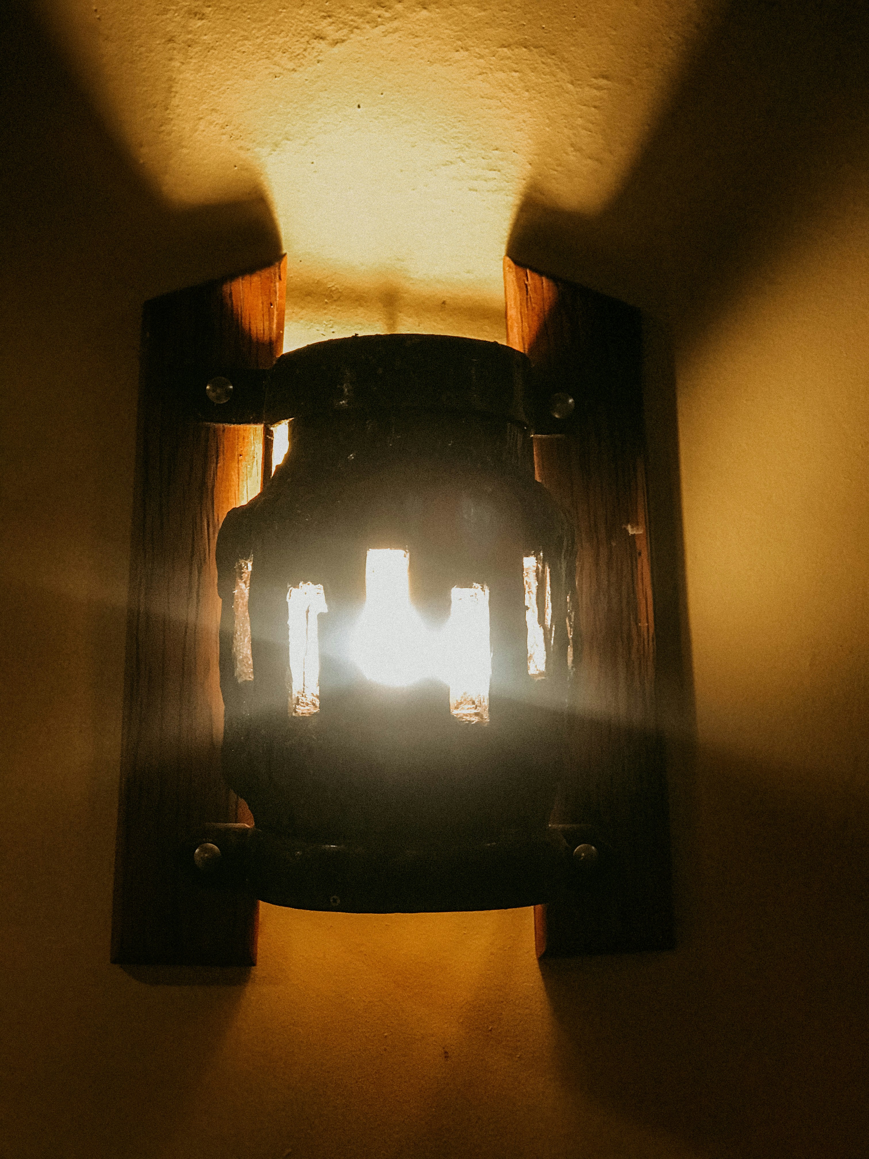 Golden Quiet: Lantern Illumination Through a Rustic Wood Frame