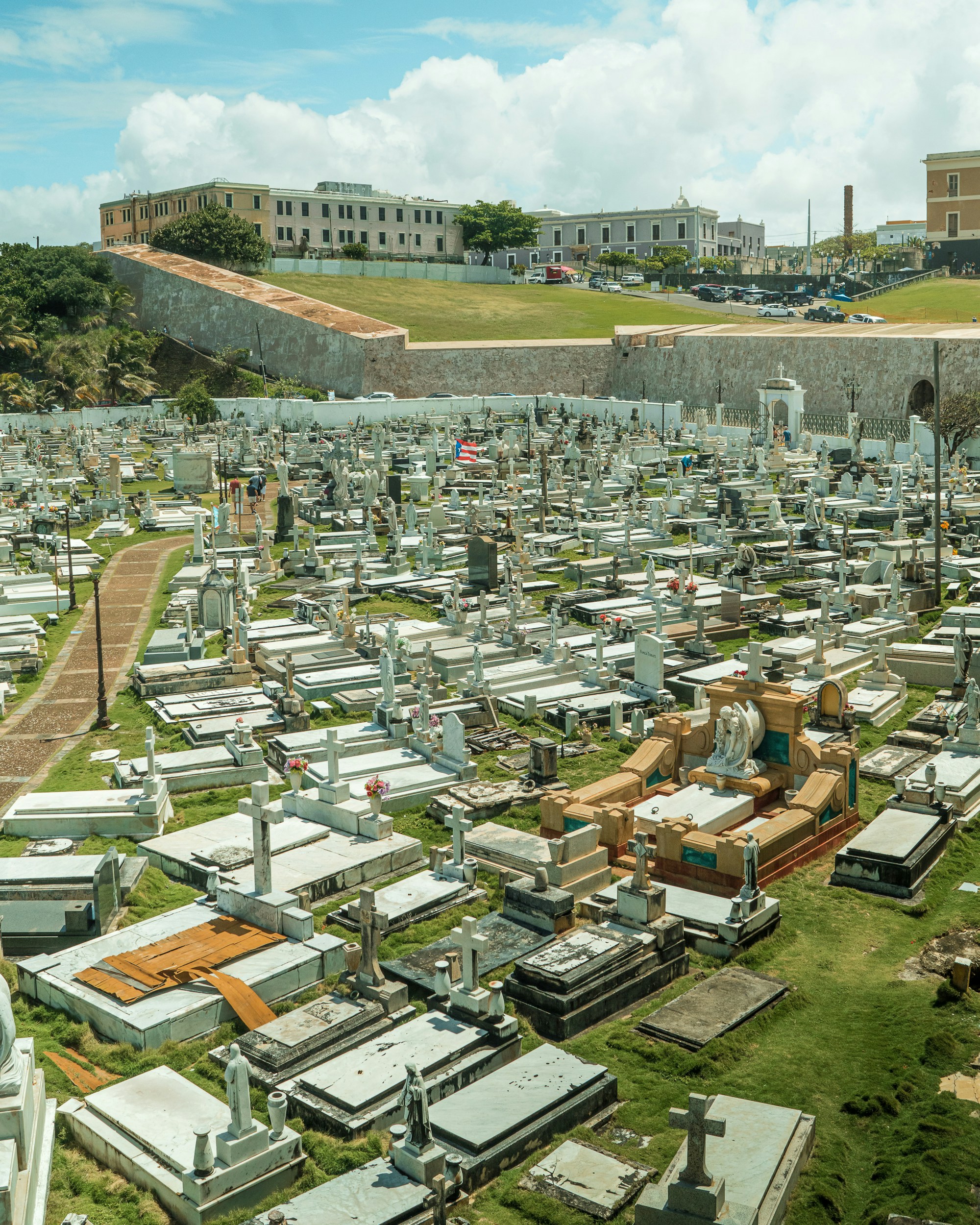 Stone Sea Beyond the Fortress Wall: A Sunlit Cemetery Unfolding Toward History