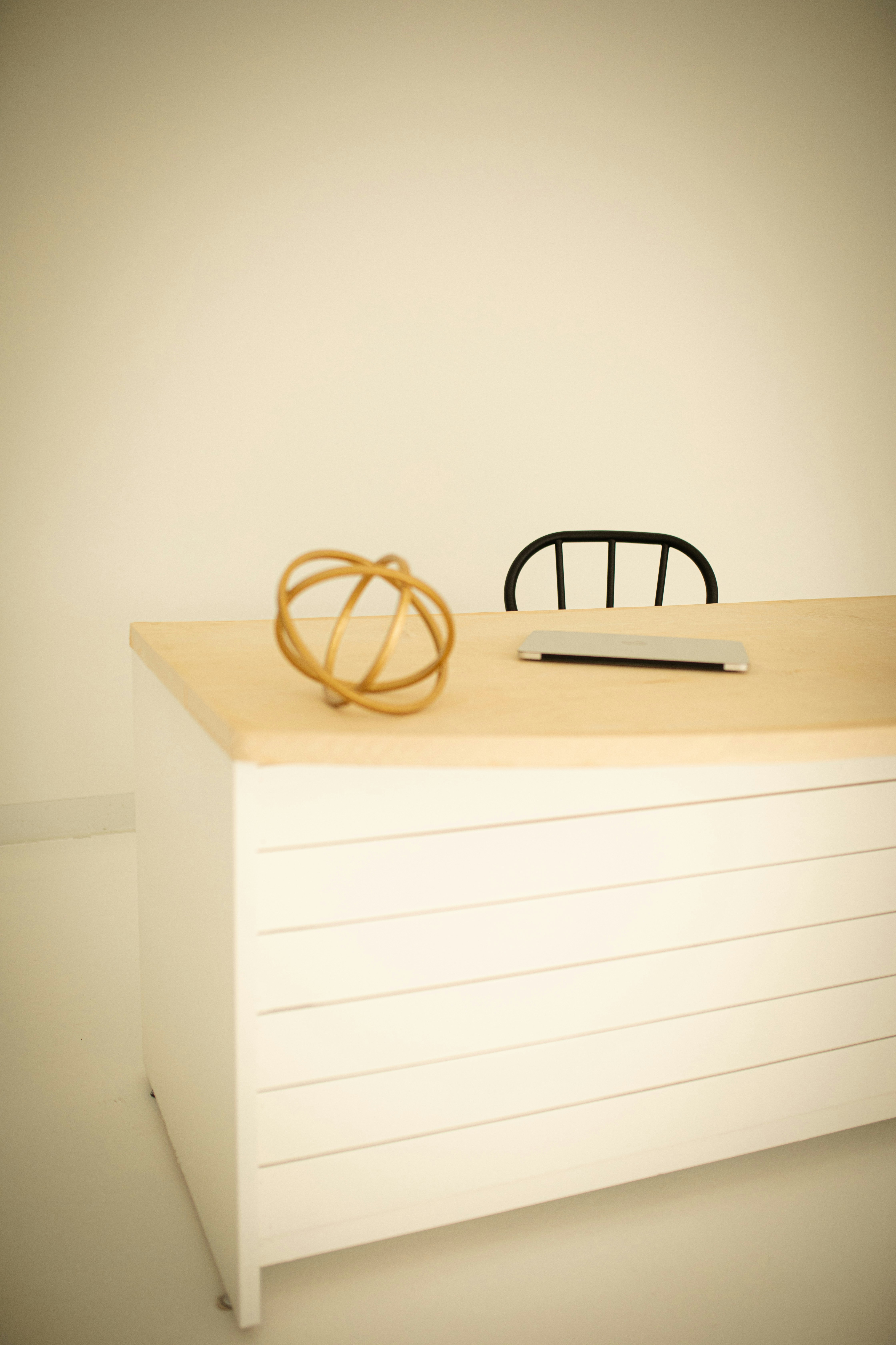 a desk with a chair and a laptop on it
