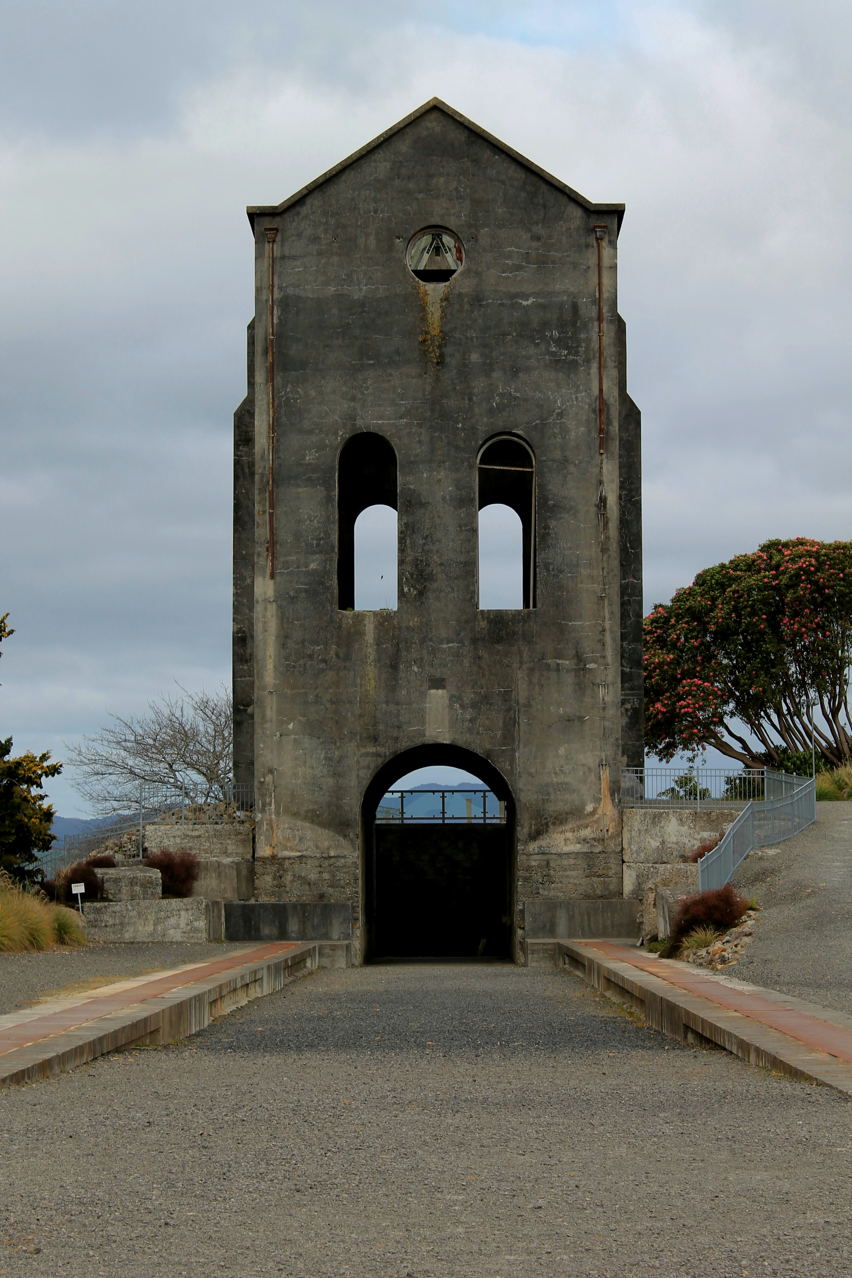 Abandoned Bell-Tower Gateway under cloudy skies