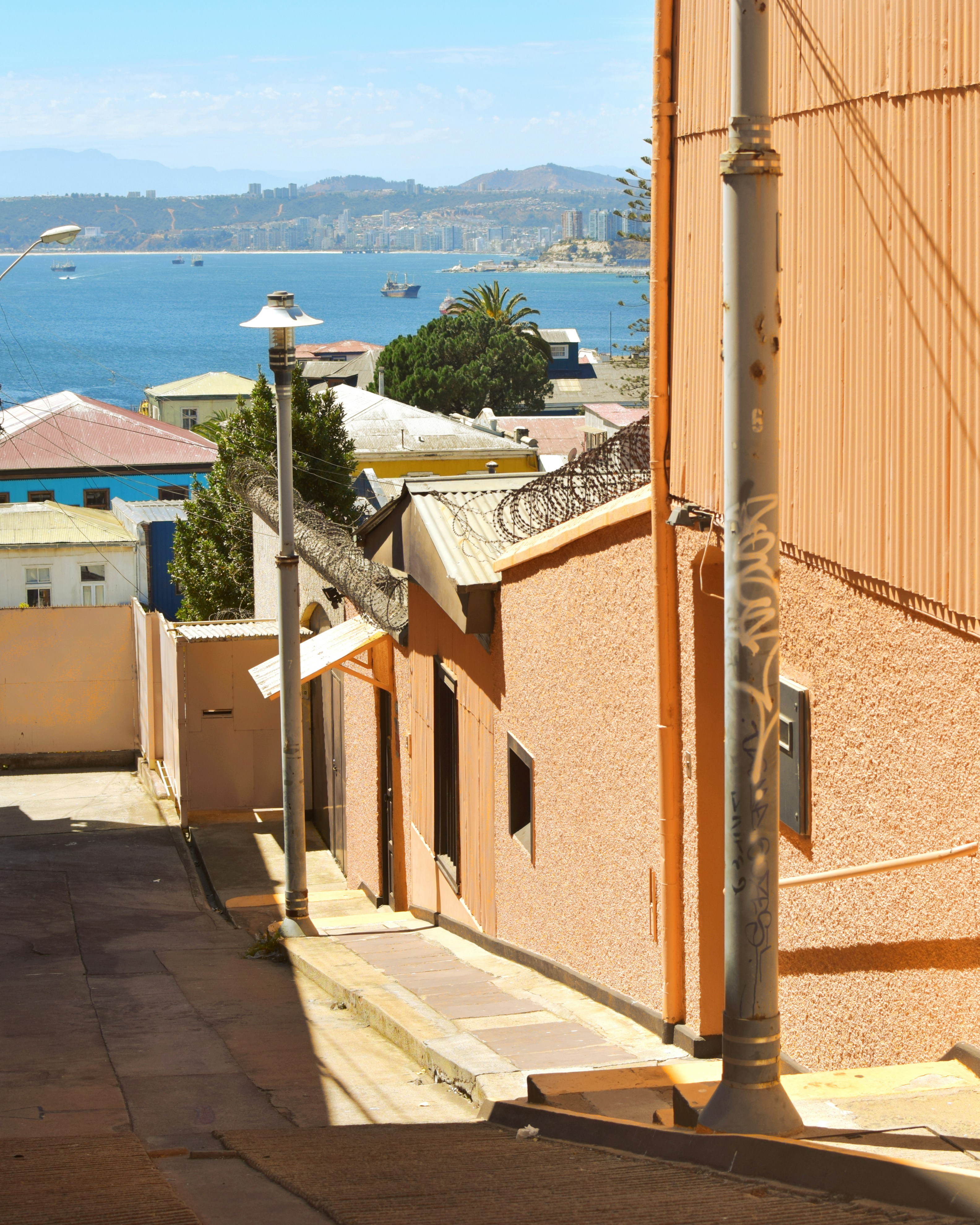 A view of the ocean from a street in a small town photo – Free Street ...