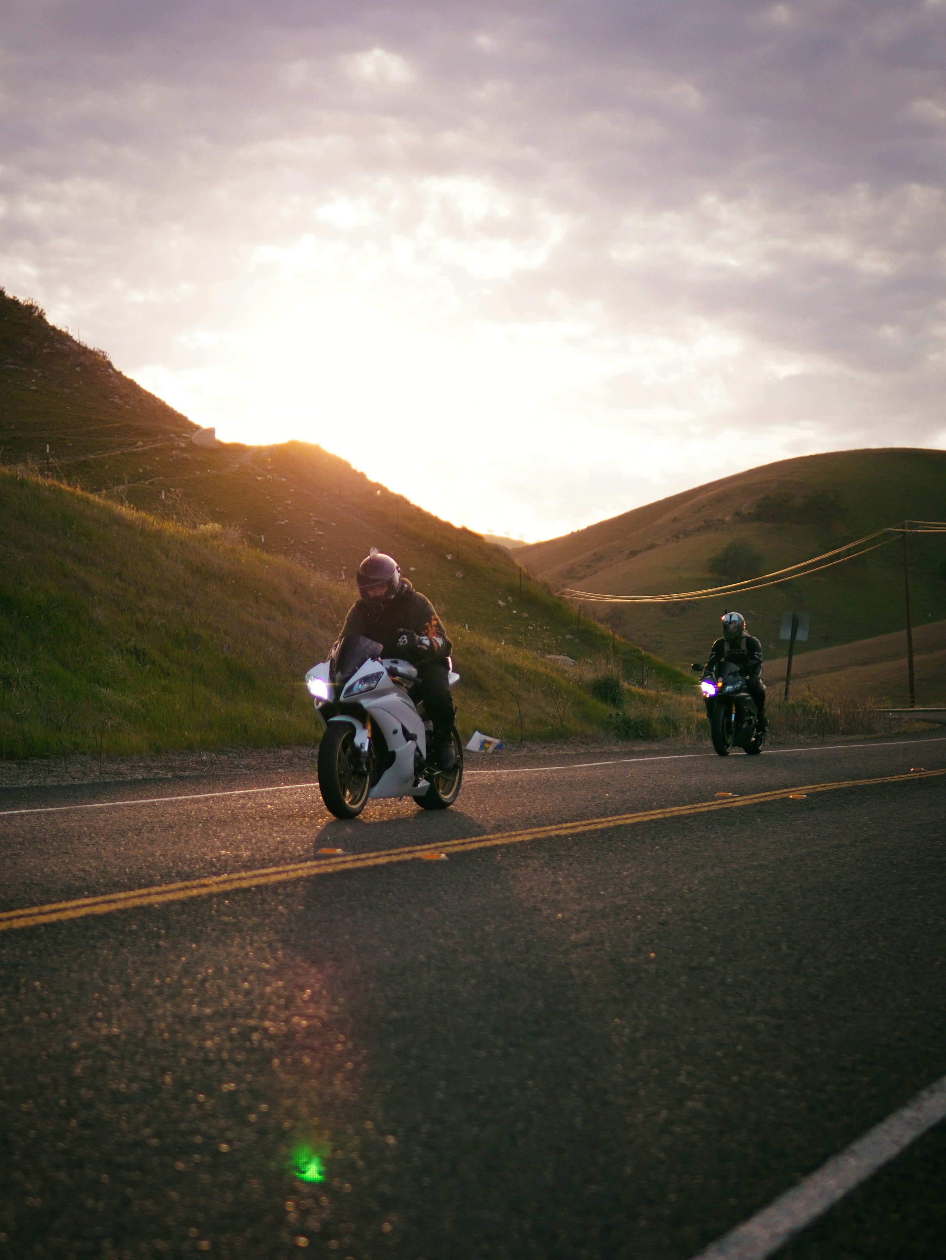 A man riding a motorcycle down a curvy road photo – Free Motorcycle ...